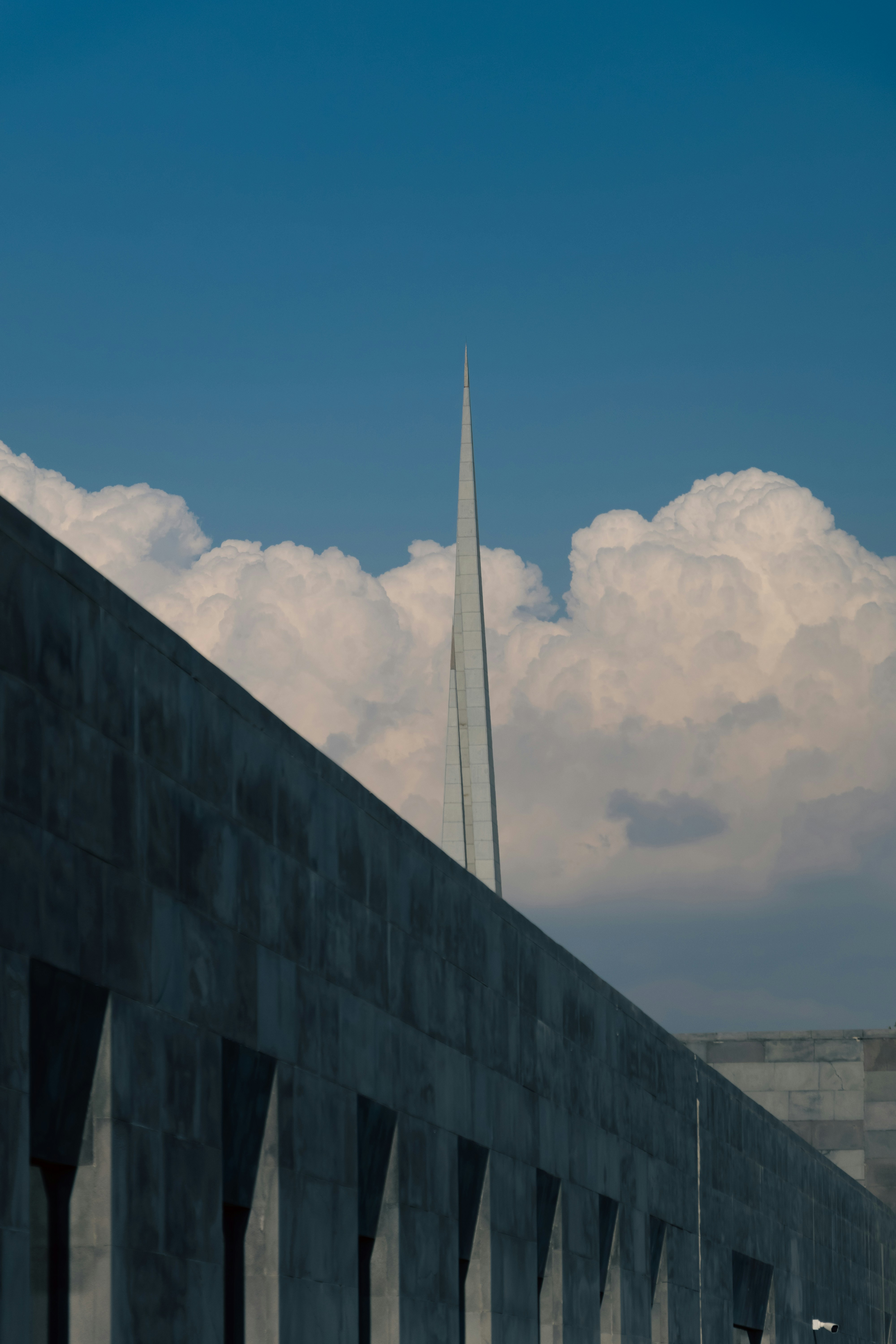 Spire Above the Concrete Corridor: A Vertical Needle Piercing the Sky