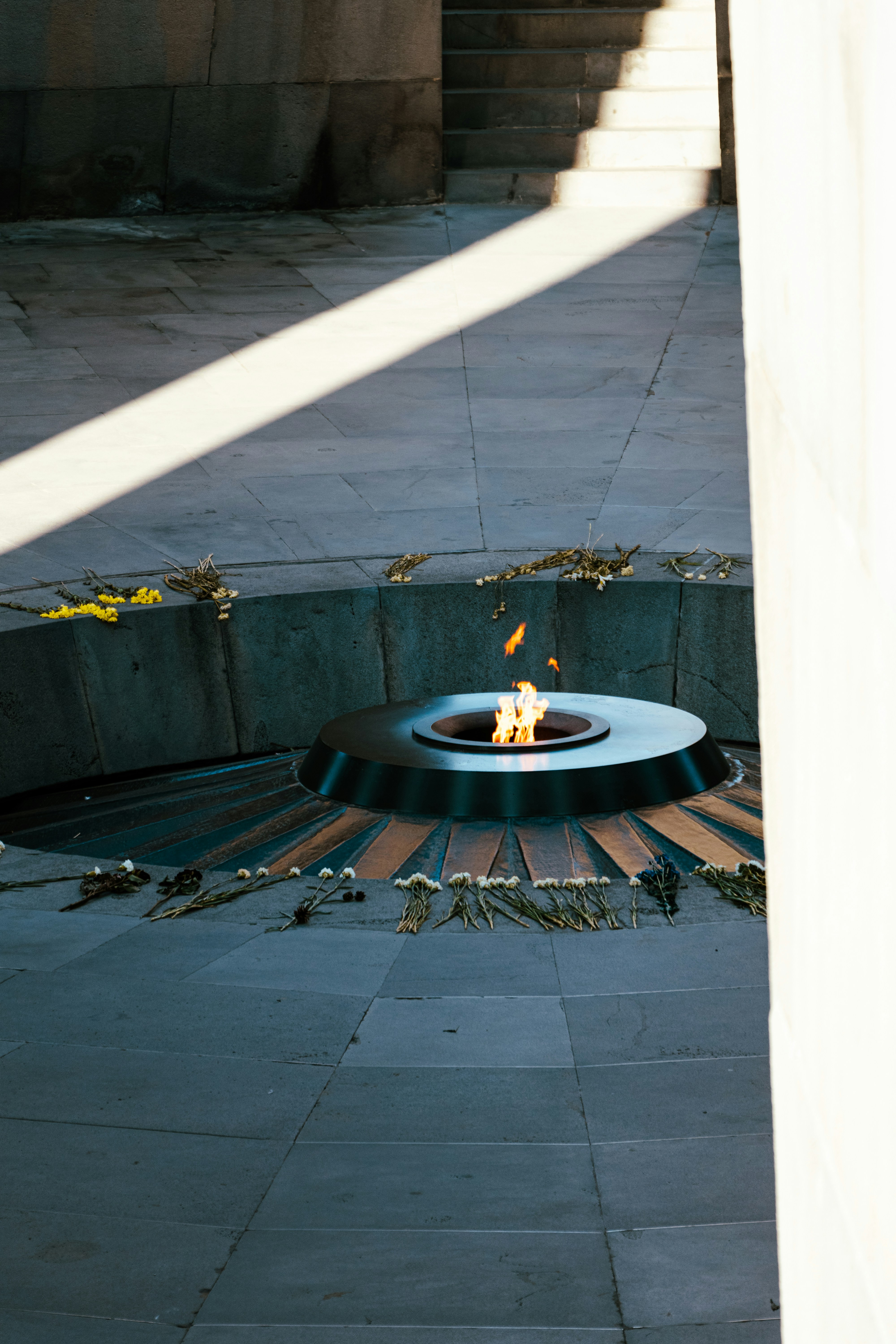 Eternal Flame in a Circular Altar Under a Slanted Sunbeam