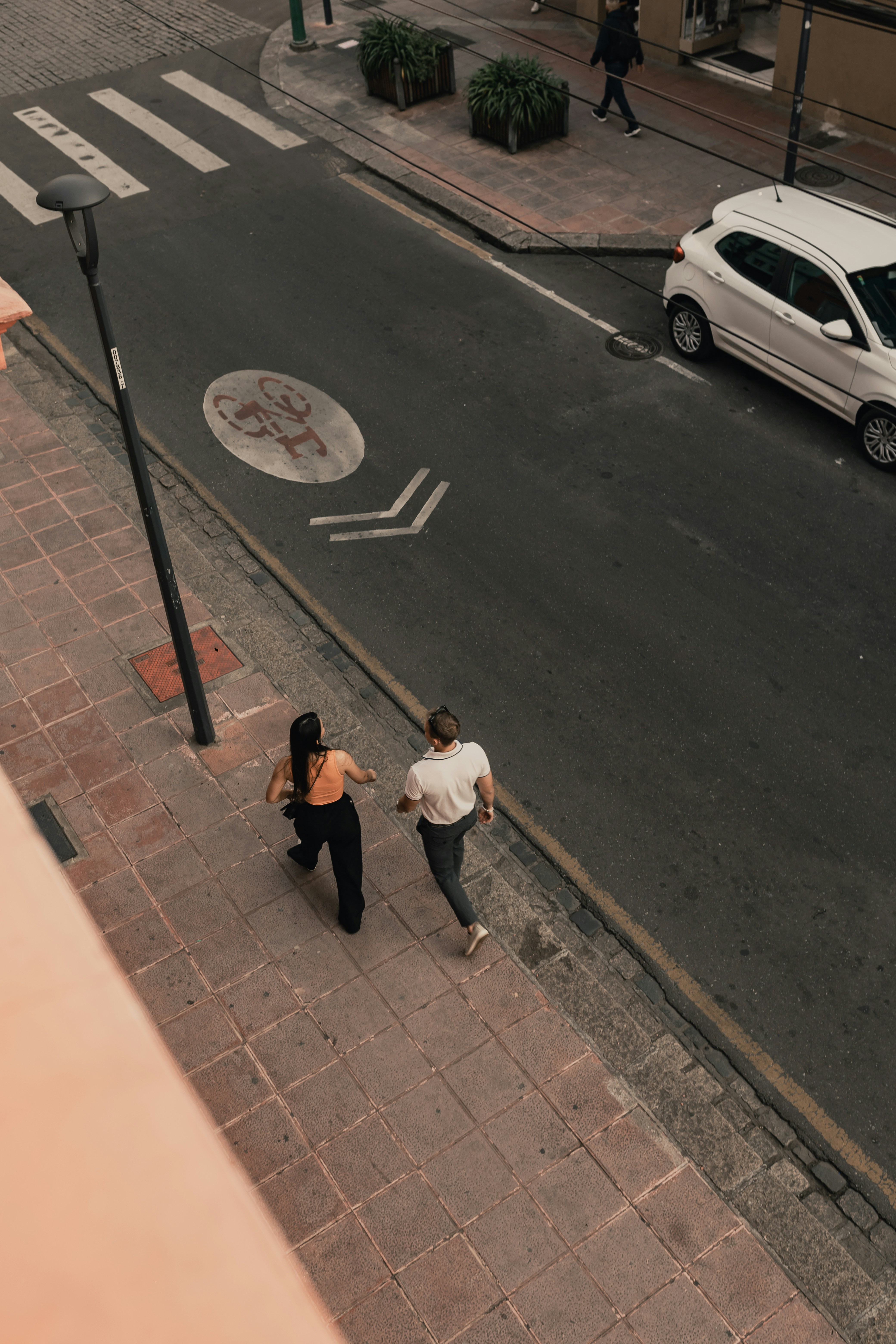 A couple of people walking down a street photo – Free Human Image on ...