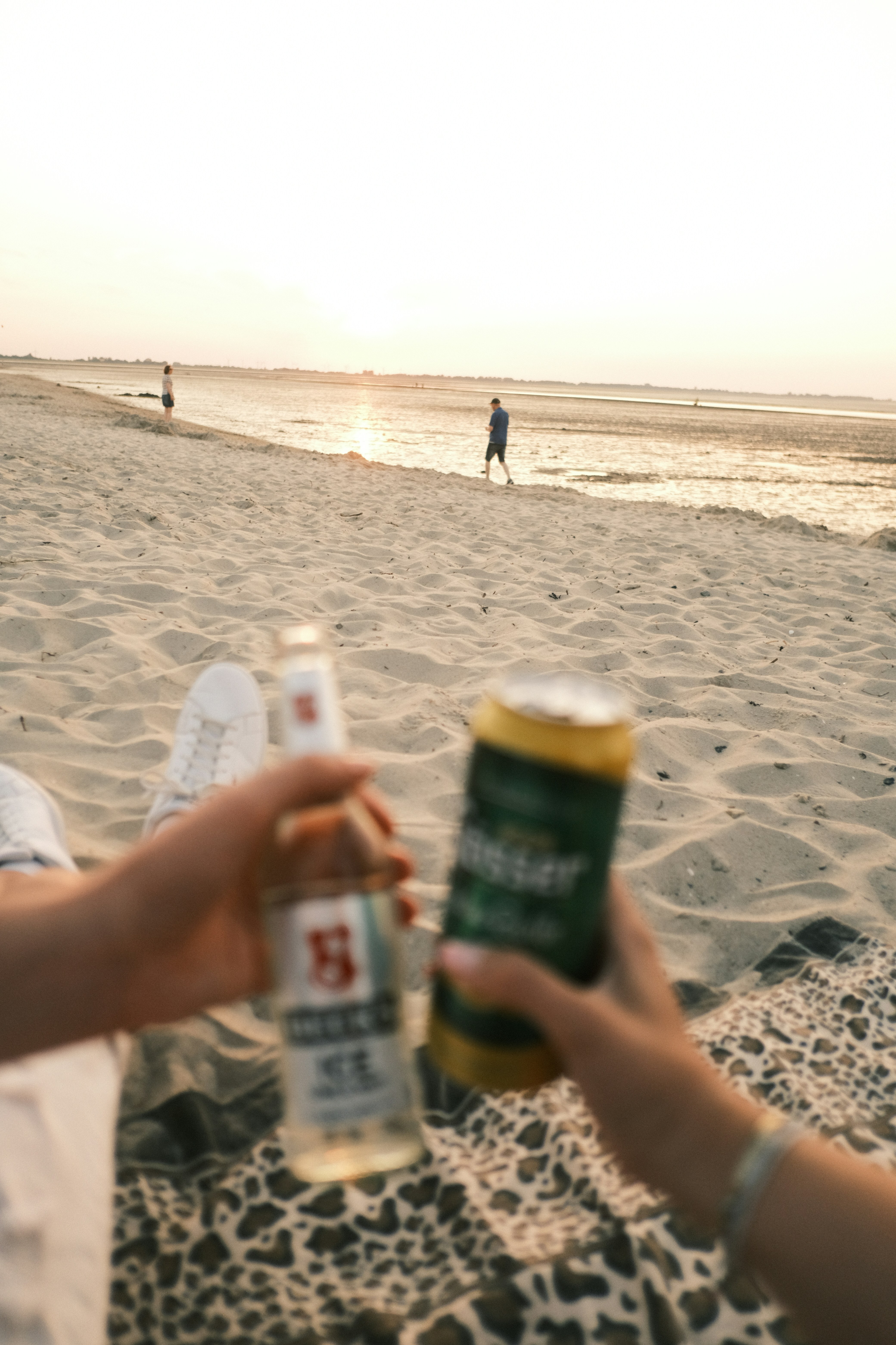 Sunset Toast at the Quiet Shore: Beachgoers in Golden Light