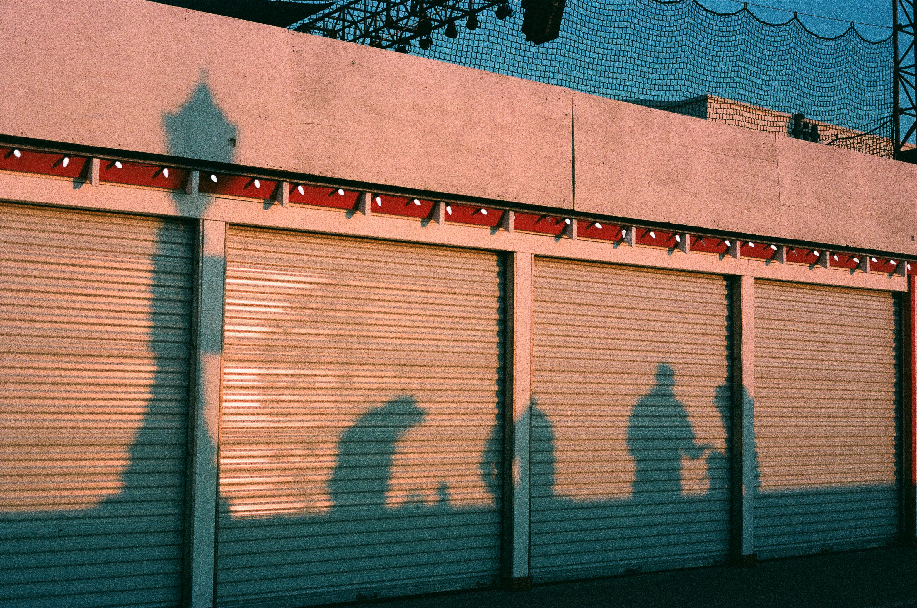The shadows of people on the side of a building photo – Free People ...