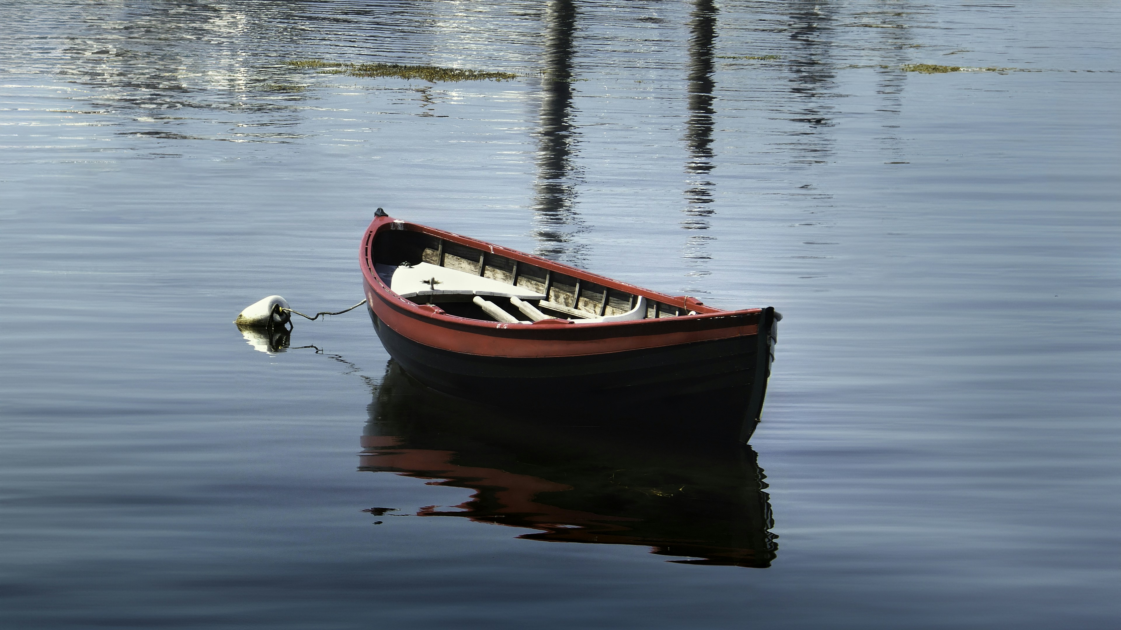 A small boat floating on top of a lake photo – Free Wallpaper Image on ...