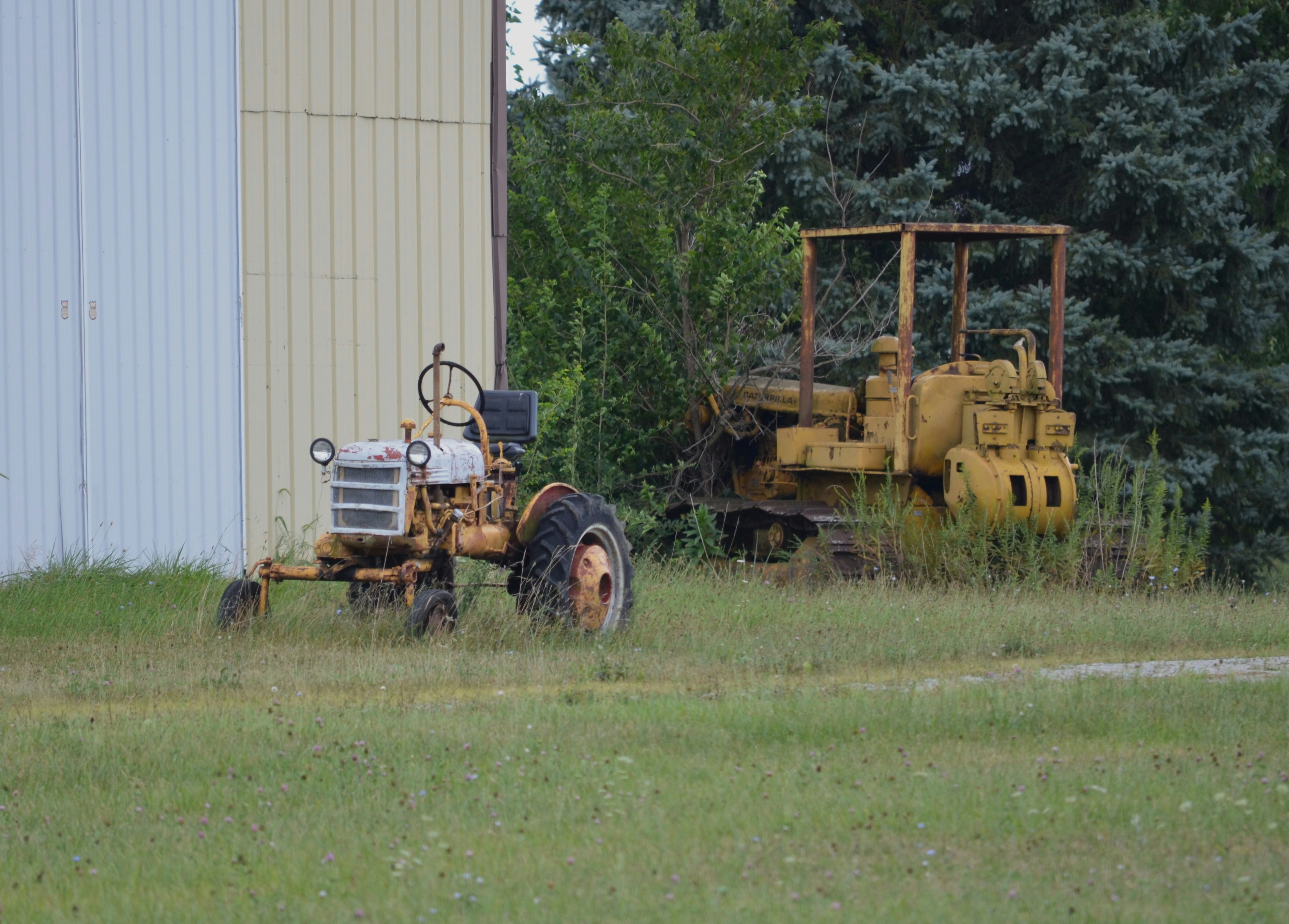 Echoes of the Field: Weathered Tractors by a Quiet Farm Shed