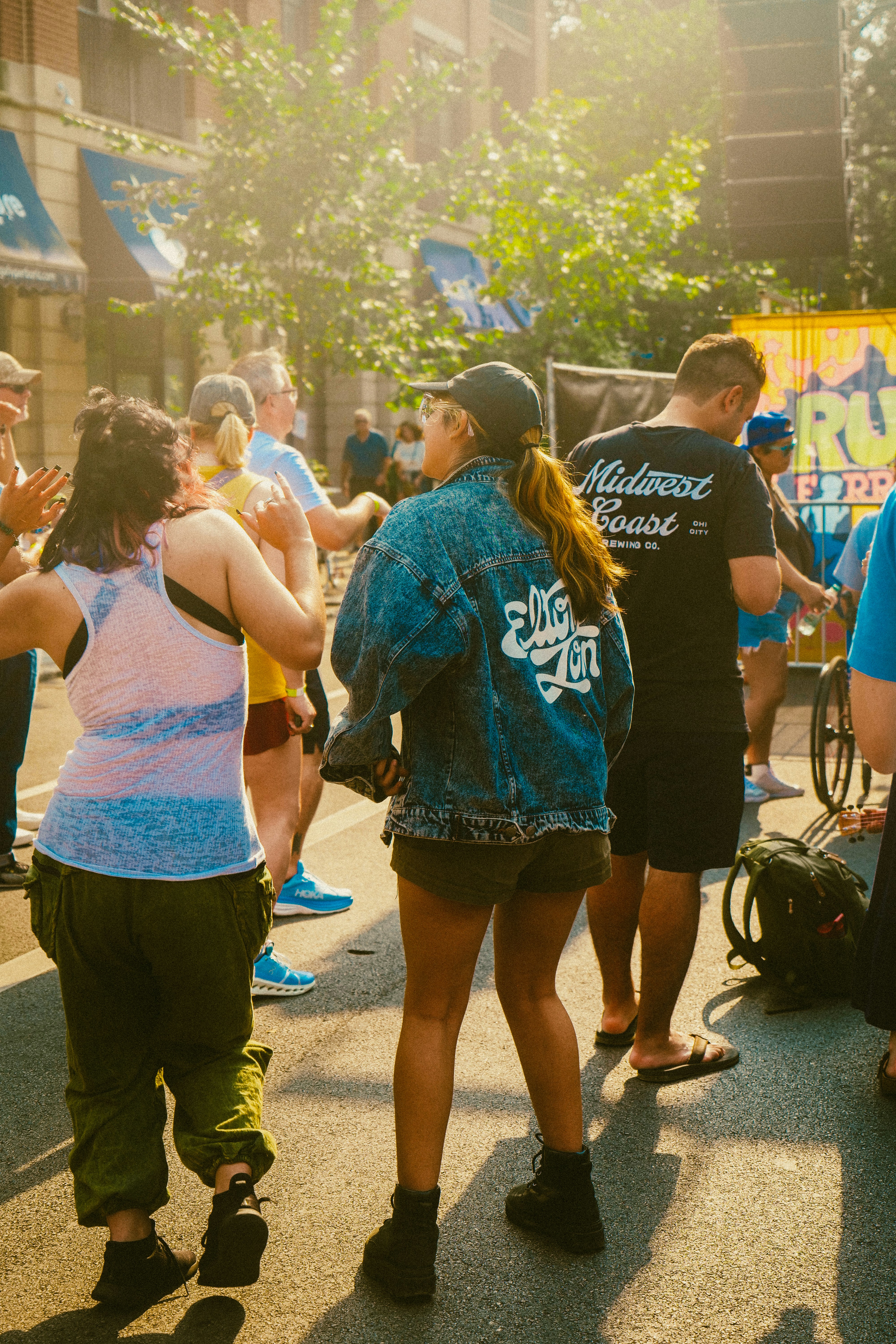 Denim in the Sun: a Back-Facing Moment Amid a City Street Crowd