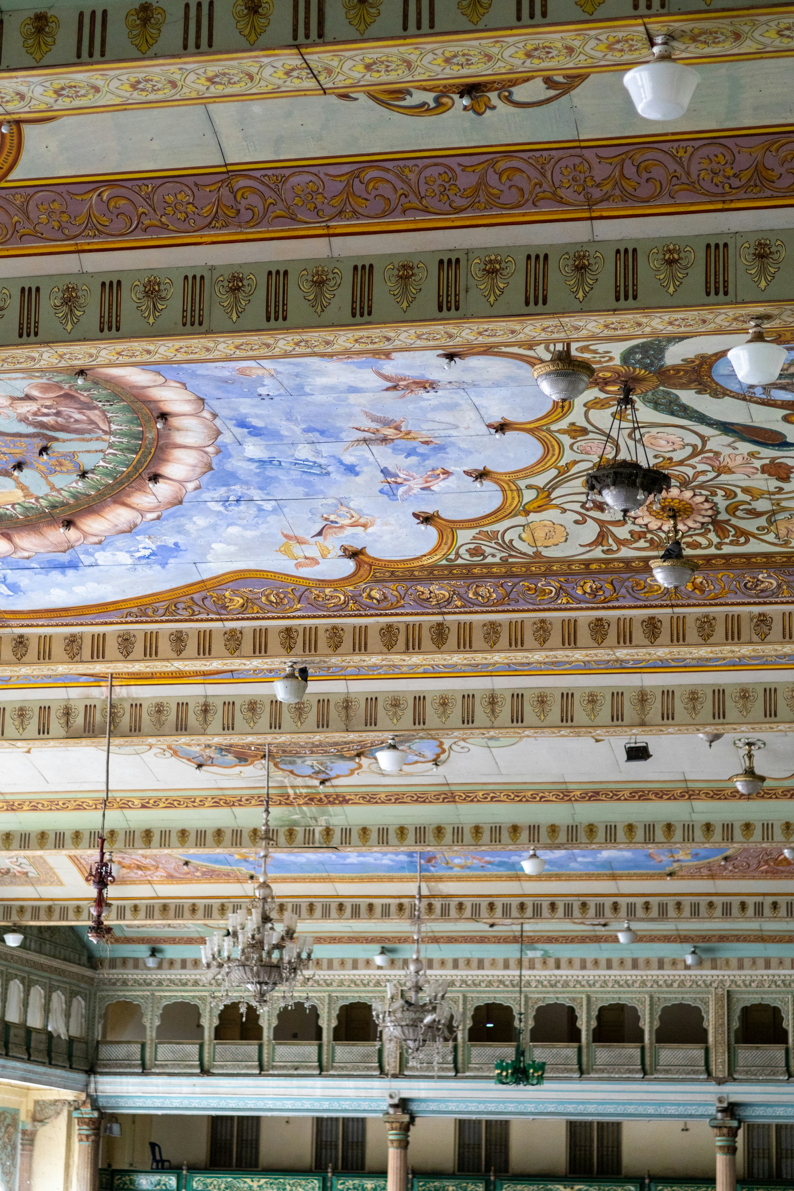 Ornate Ceiling Gallery: Painted Frescoes and Chandeliers in a Historic Hall