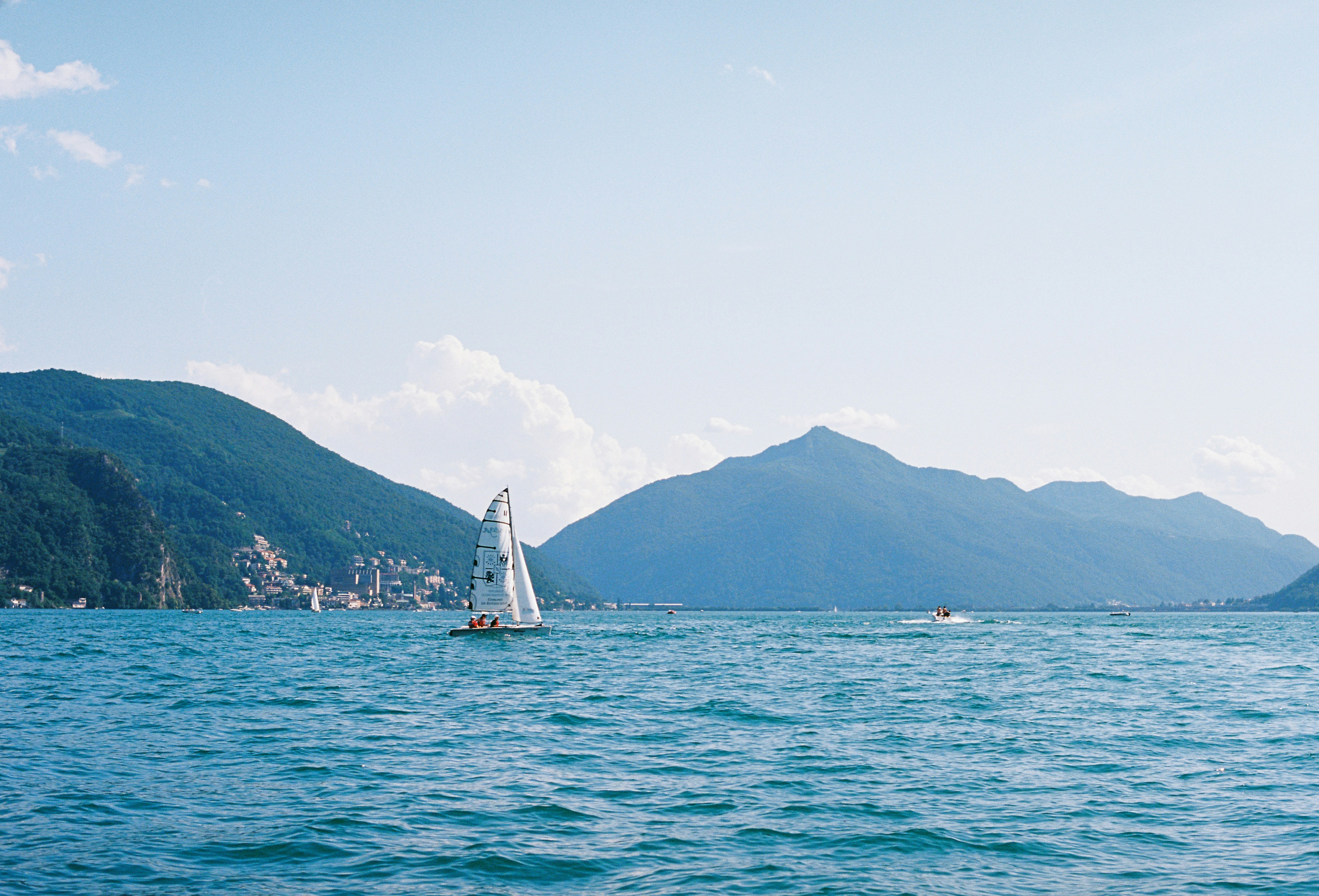 A sailboat sailing on a large body of water photo – Free Boat Image on ...