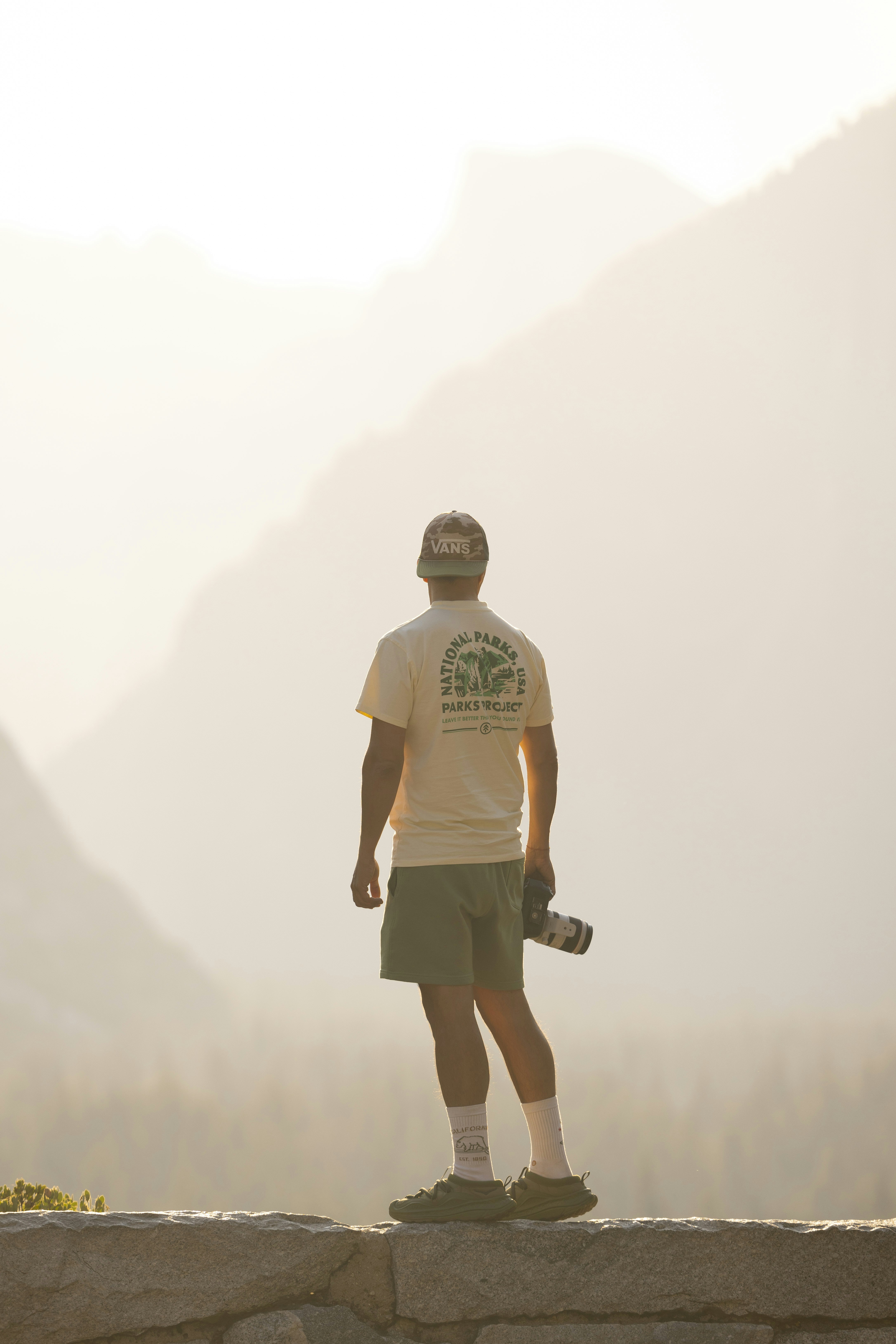 Watcher on the Ridge: A Runner with a Lens Toward the Mist