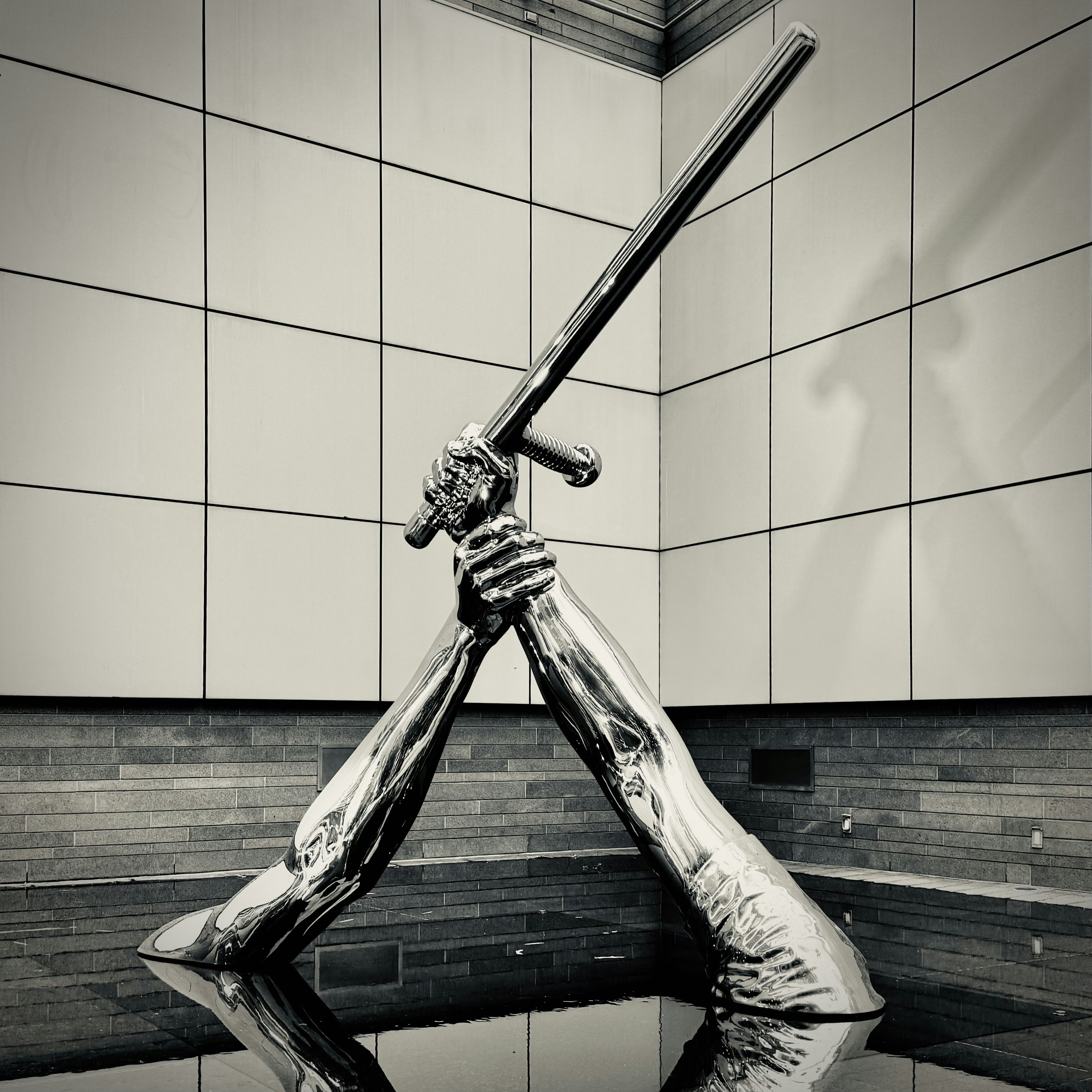 A statue of two hands holding a baseball bat
