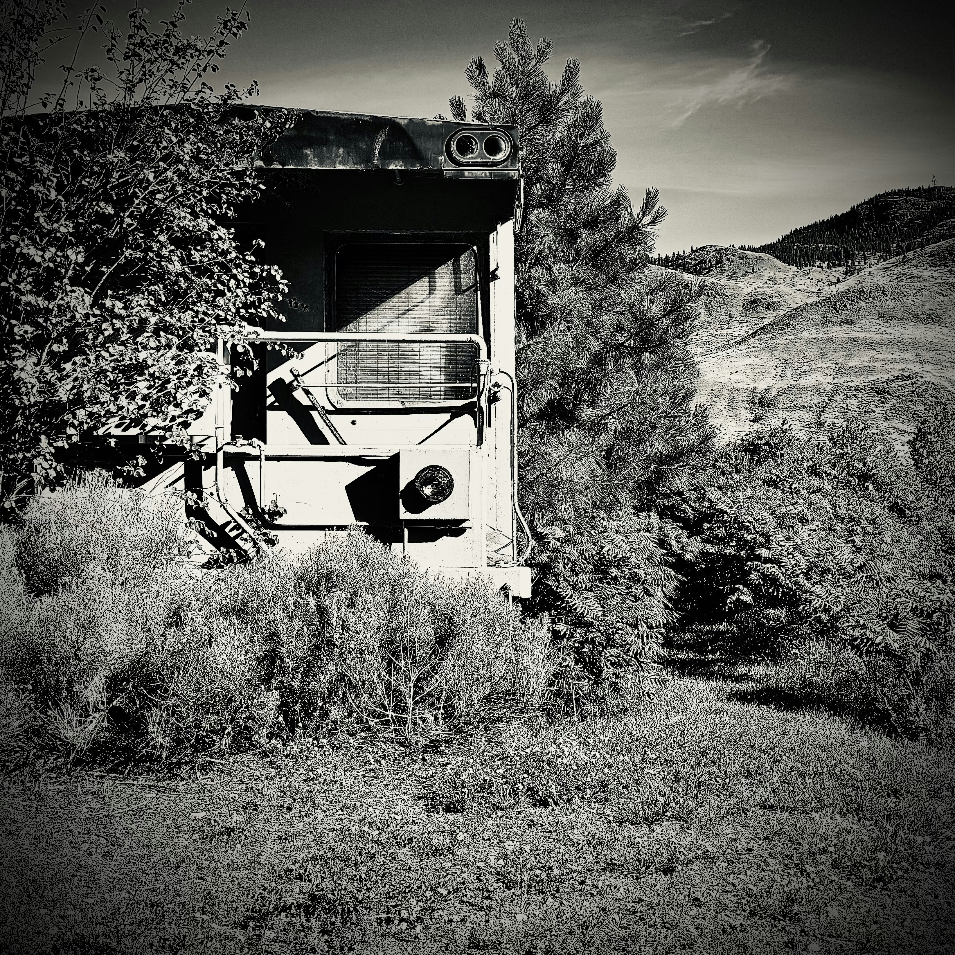 Abandoned Boxcar at the Edge of a Quiet Hillside
