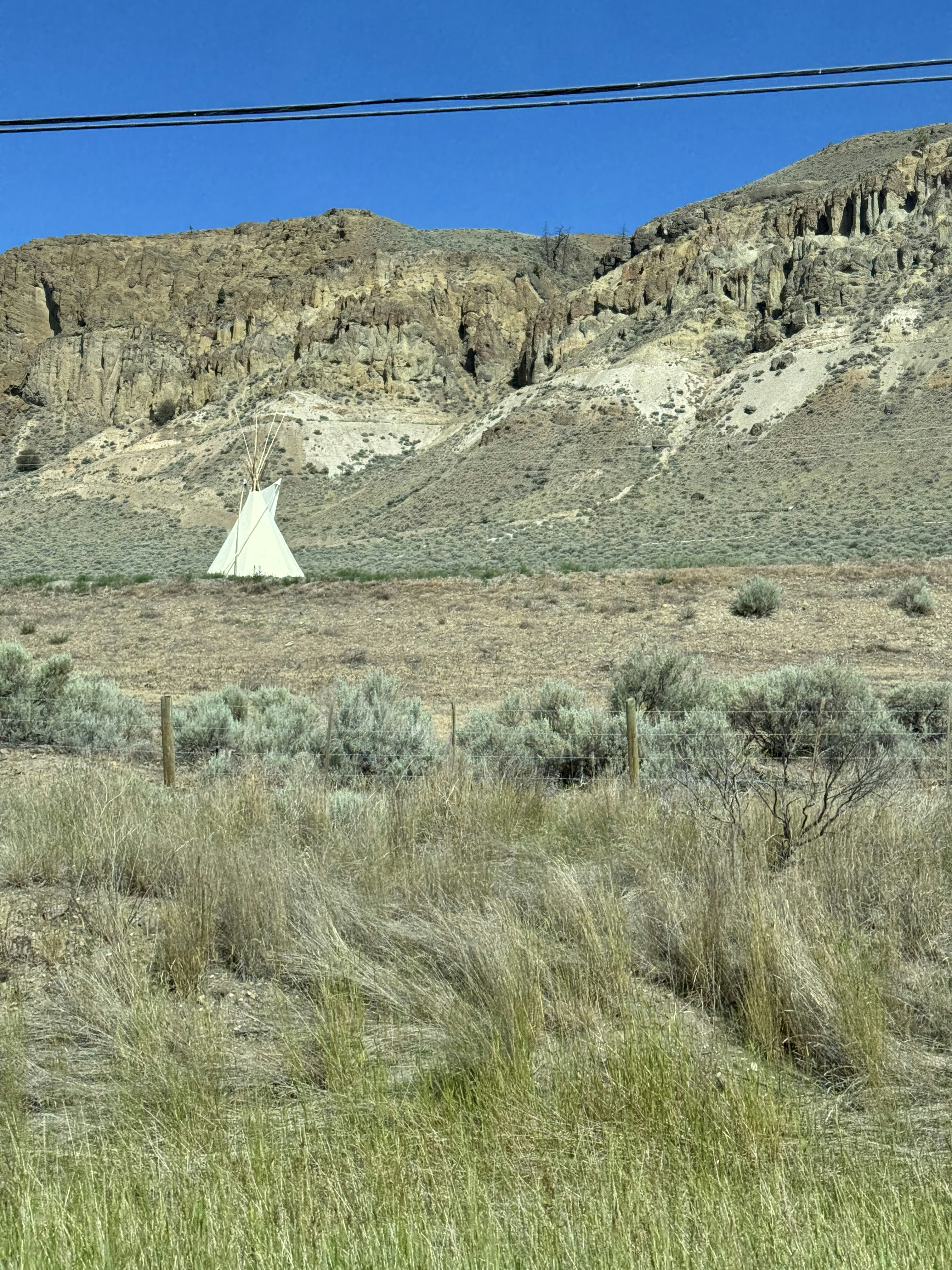 A view of a mountain range with a teepee in the foreground photo – Free ...