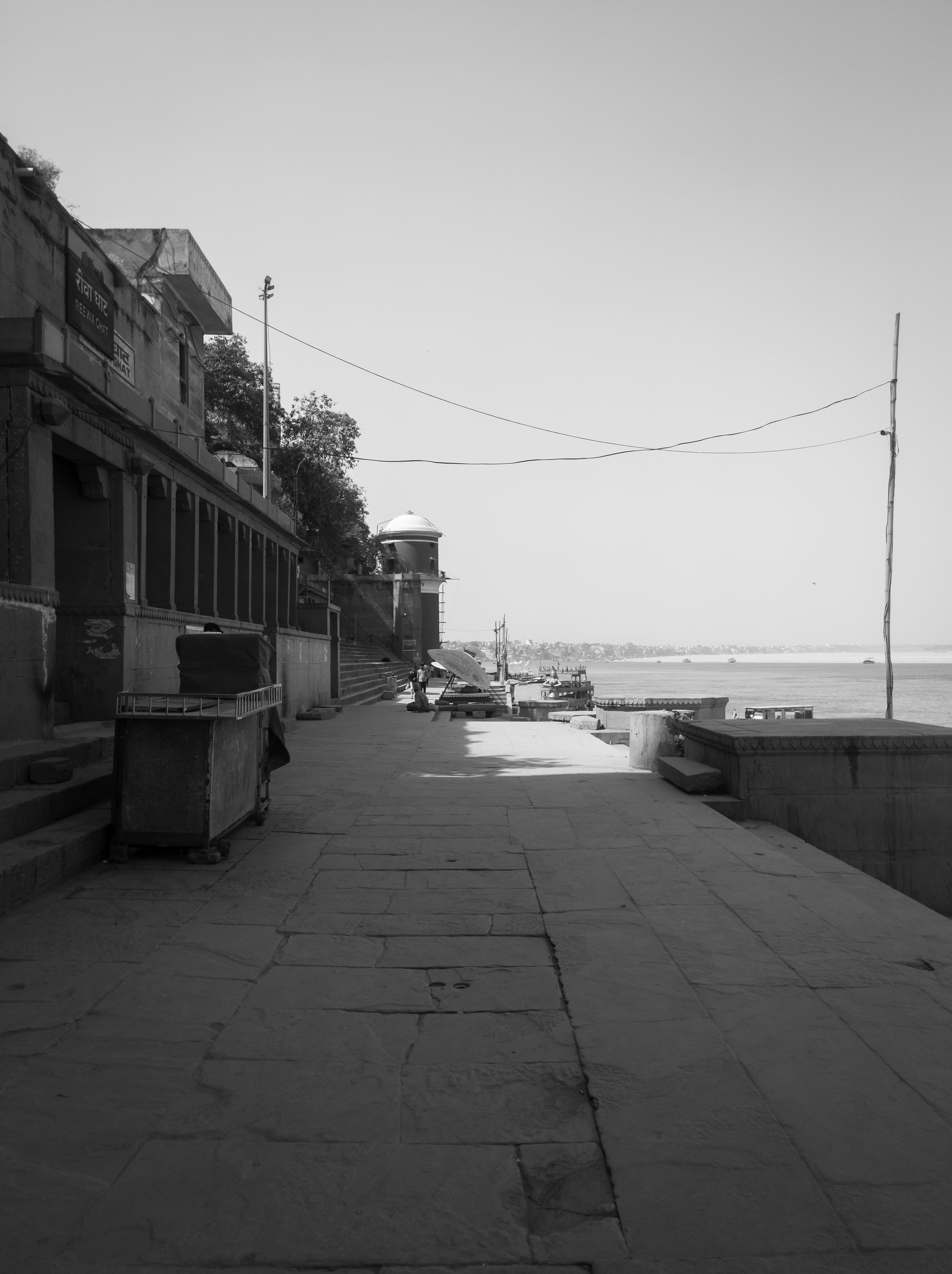 A black and white photo of a street next to the ocean photo – Free ...