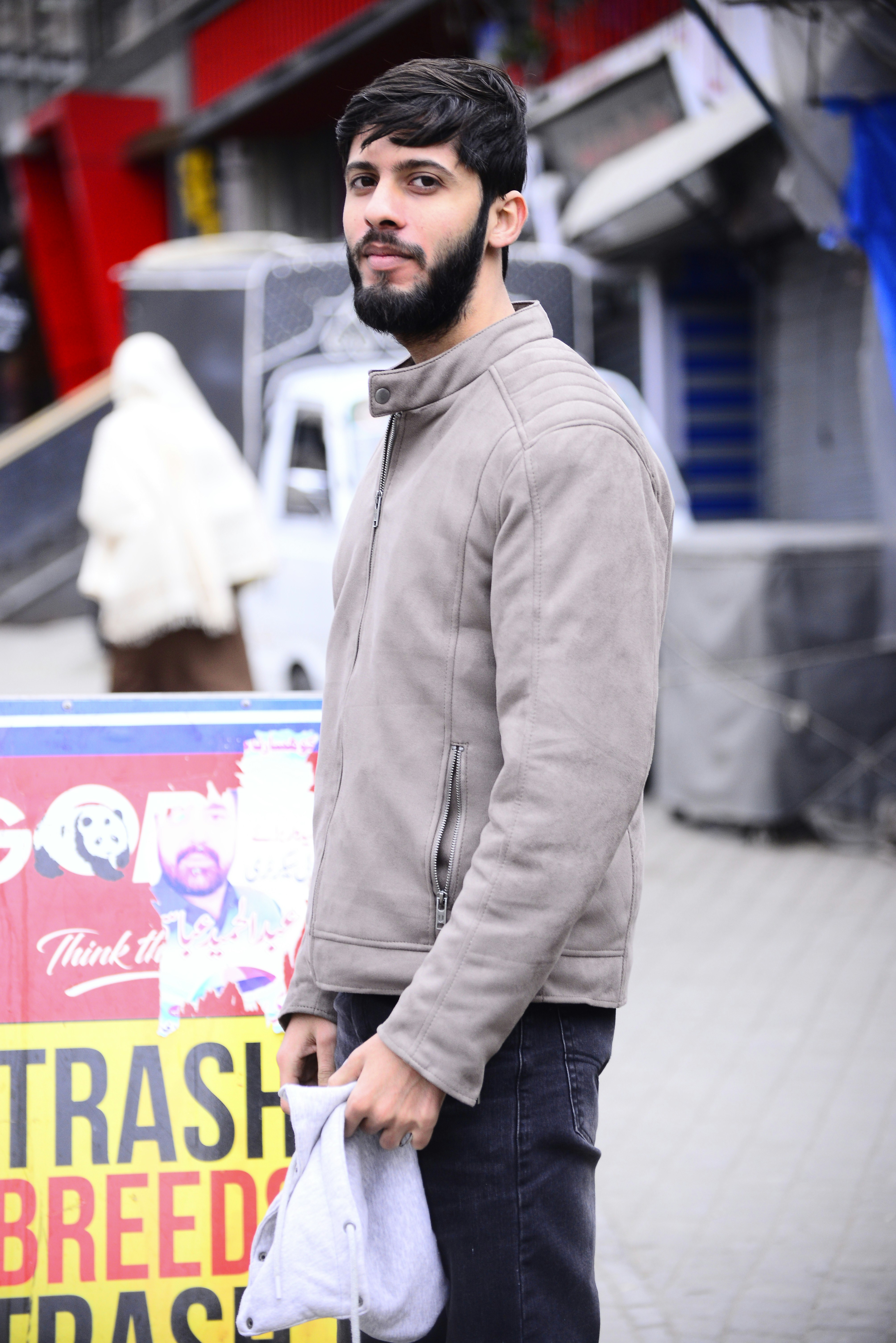 A man with a beard standing next to a sign photo – Free Poster Image on ...