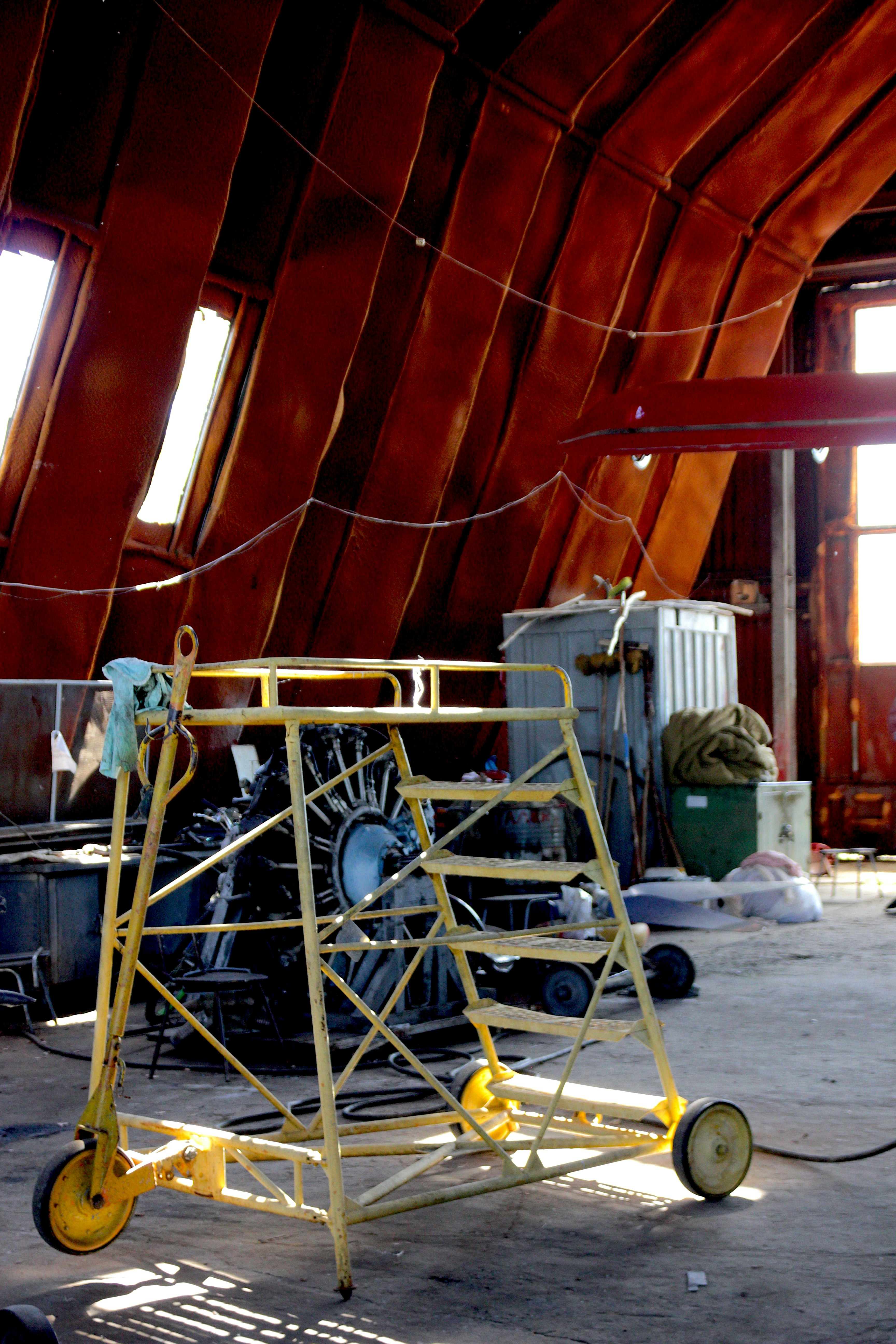 Sunlit Yellow Scaffold in a Rust-Tinted Workshop