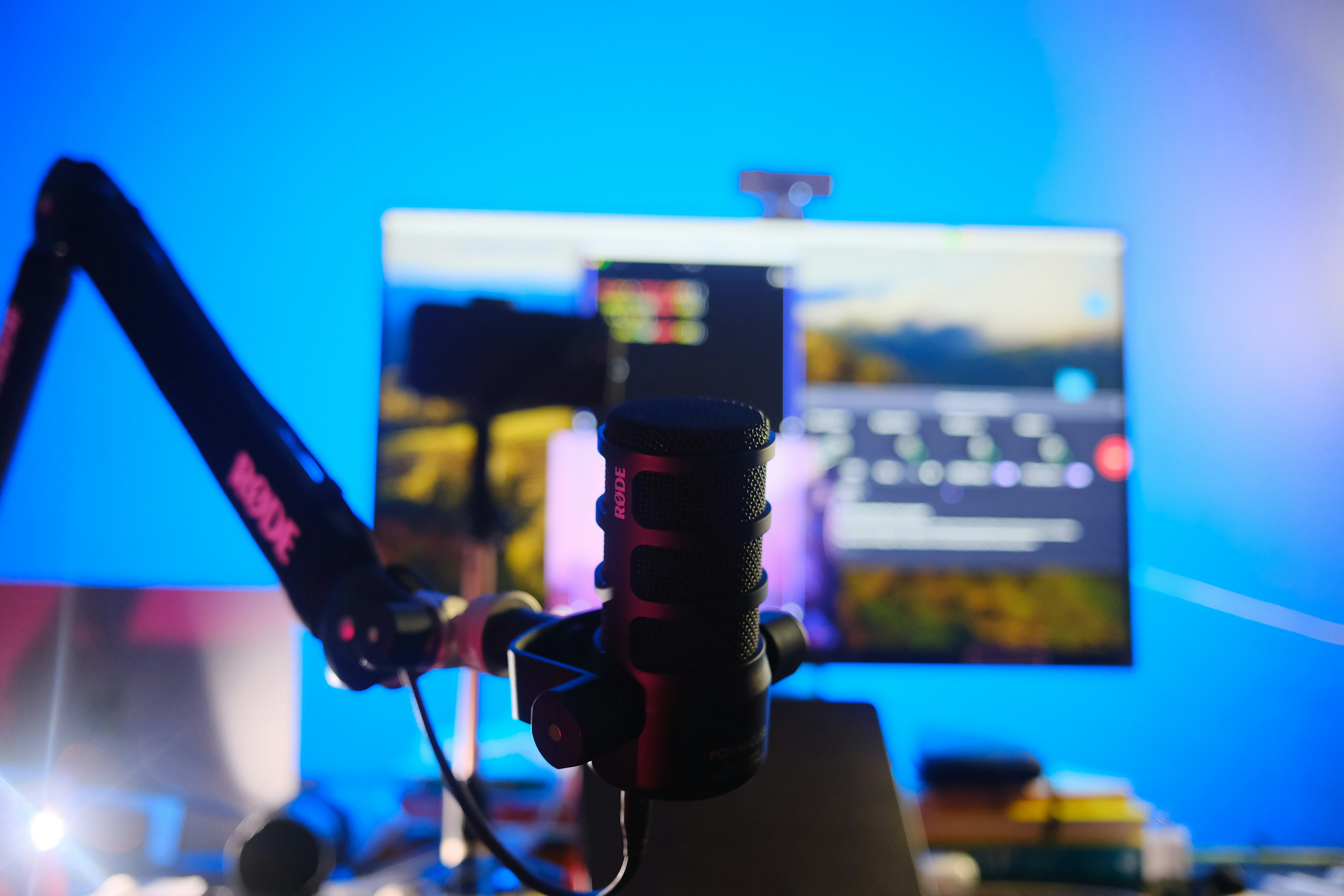 Mic | A blurry photo of a computer monitor and a camera