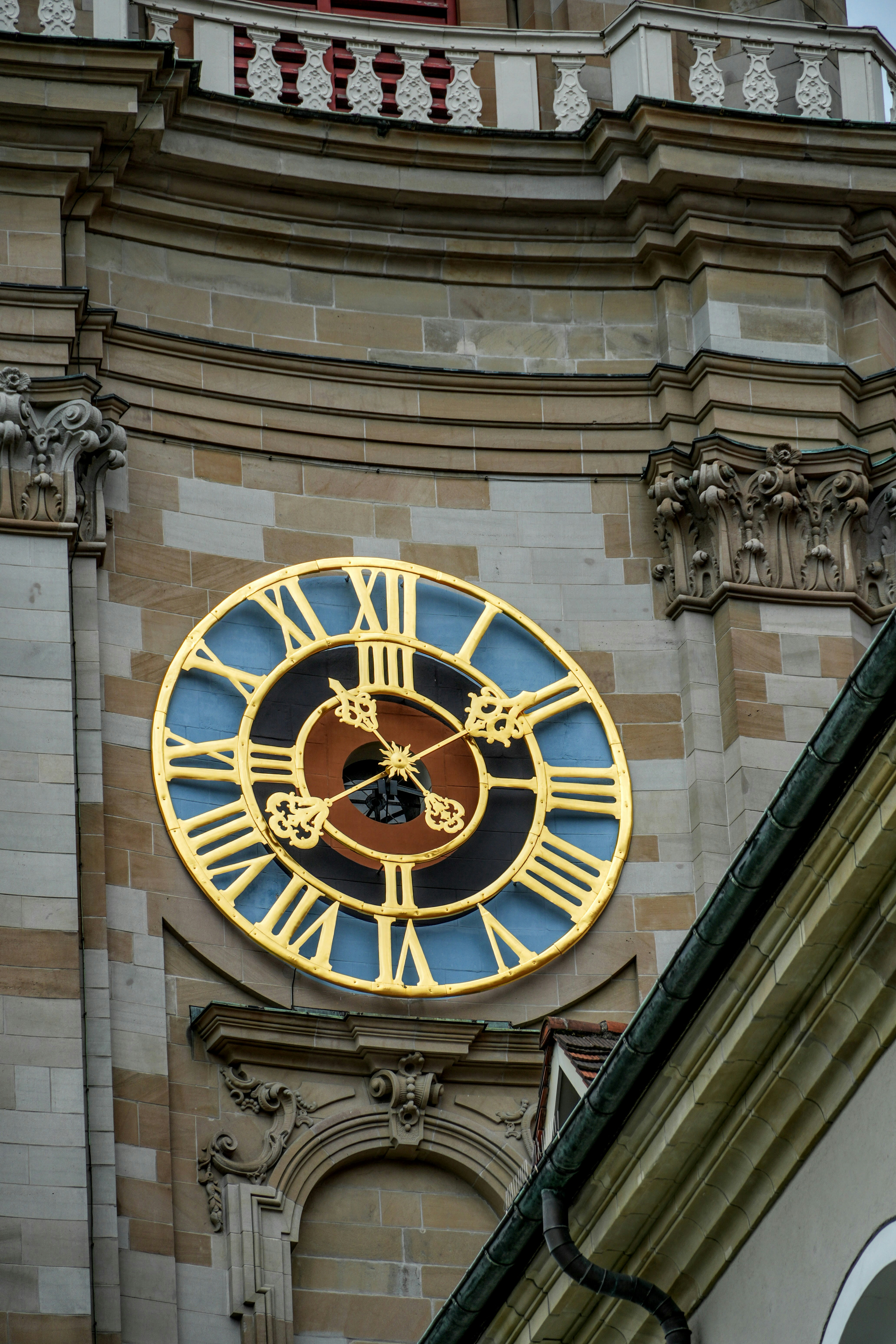 Gilded Roman Clock Crowned on a Heritage Stone Facade