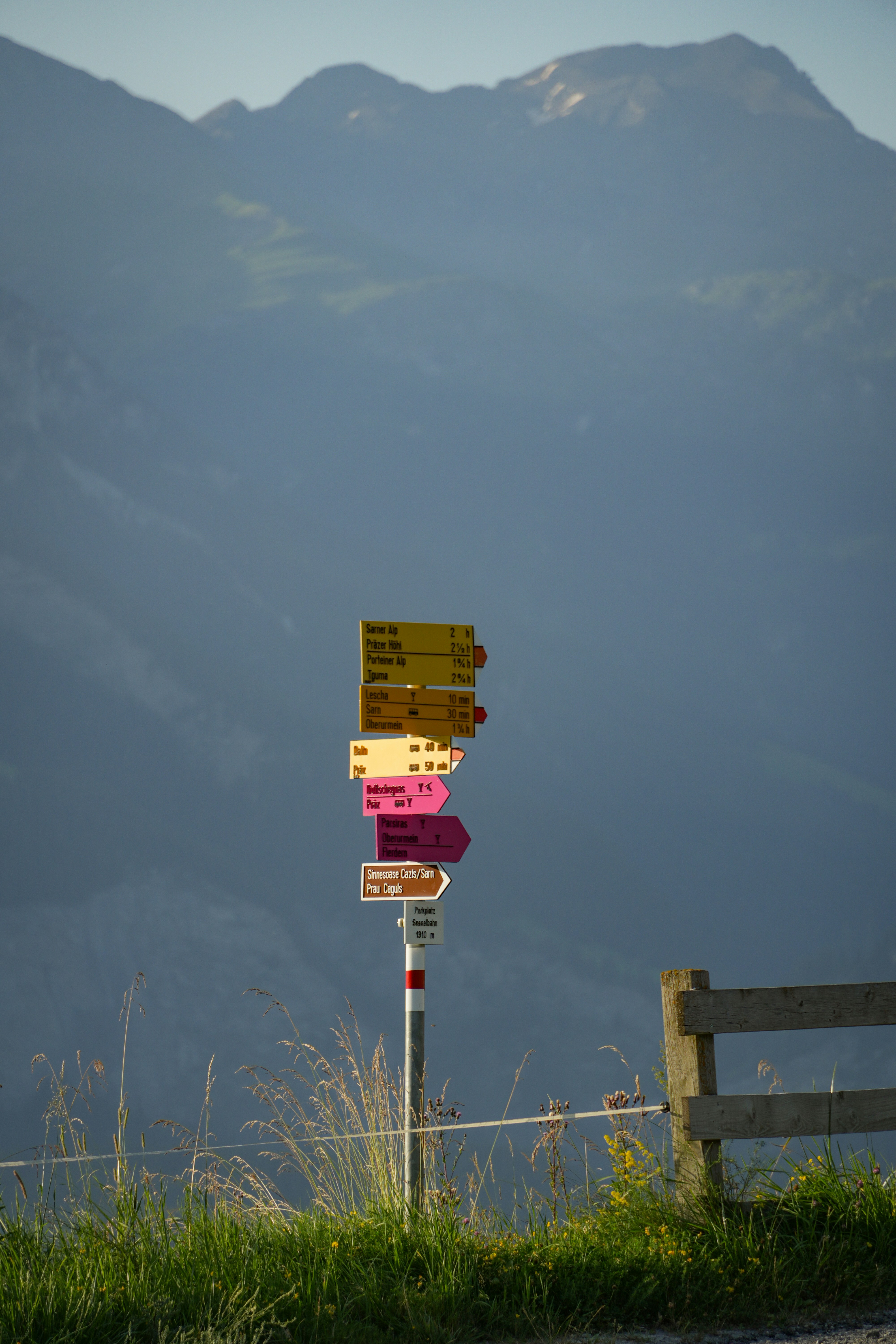 Signpost in the Mist: Colorful Directions Against Alpine Backdrop