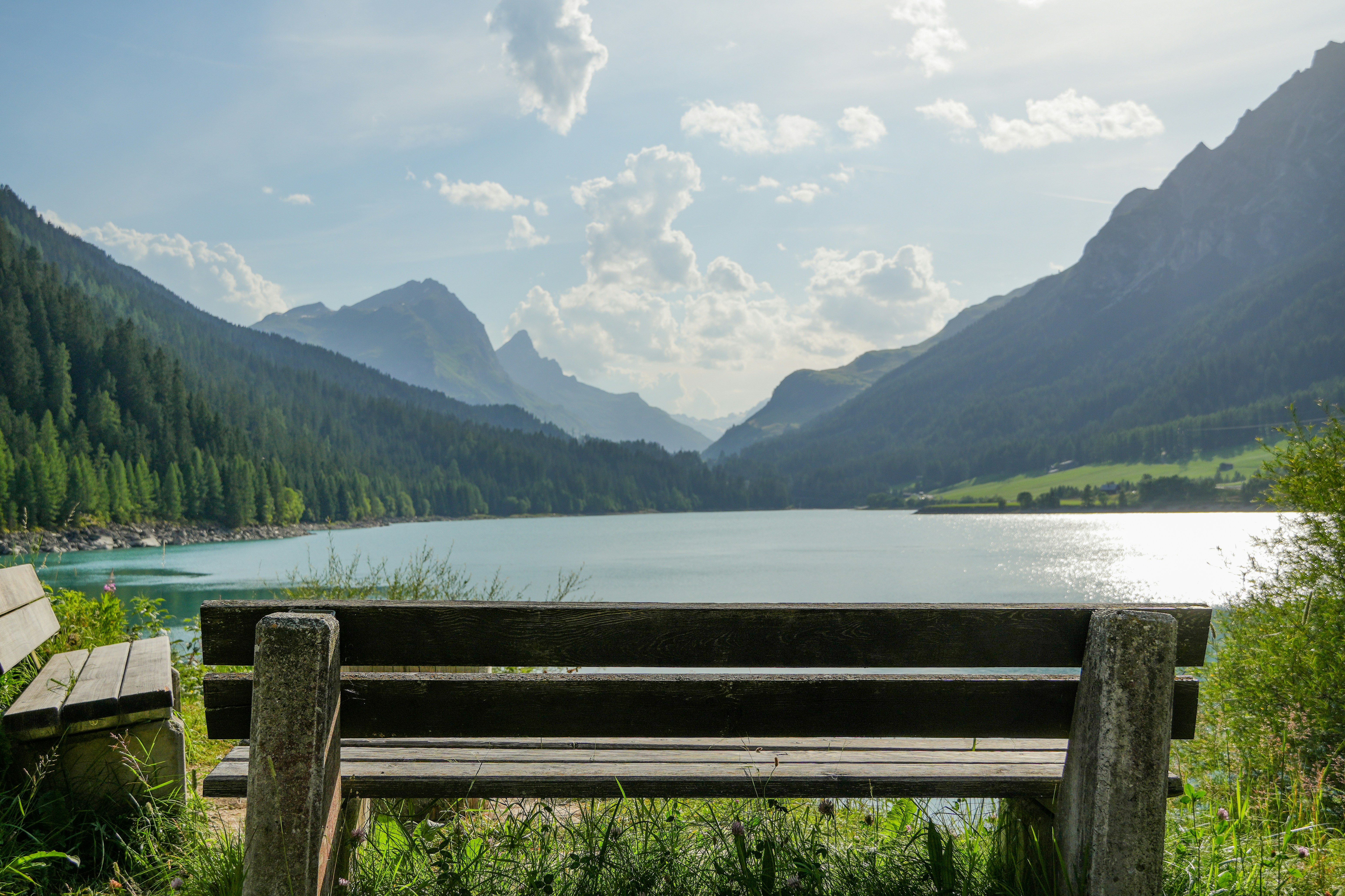 Bench at the Edge of Alpine Stillness, Framing a Turquoise Lake and Snow-Dusted Peaks