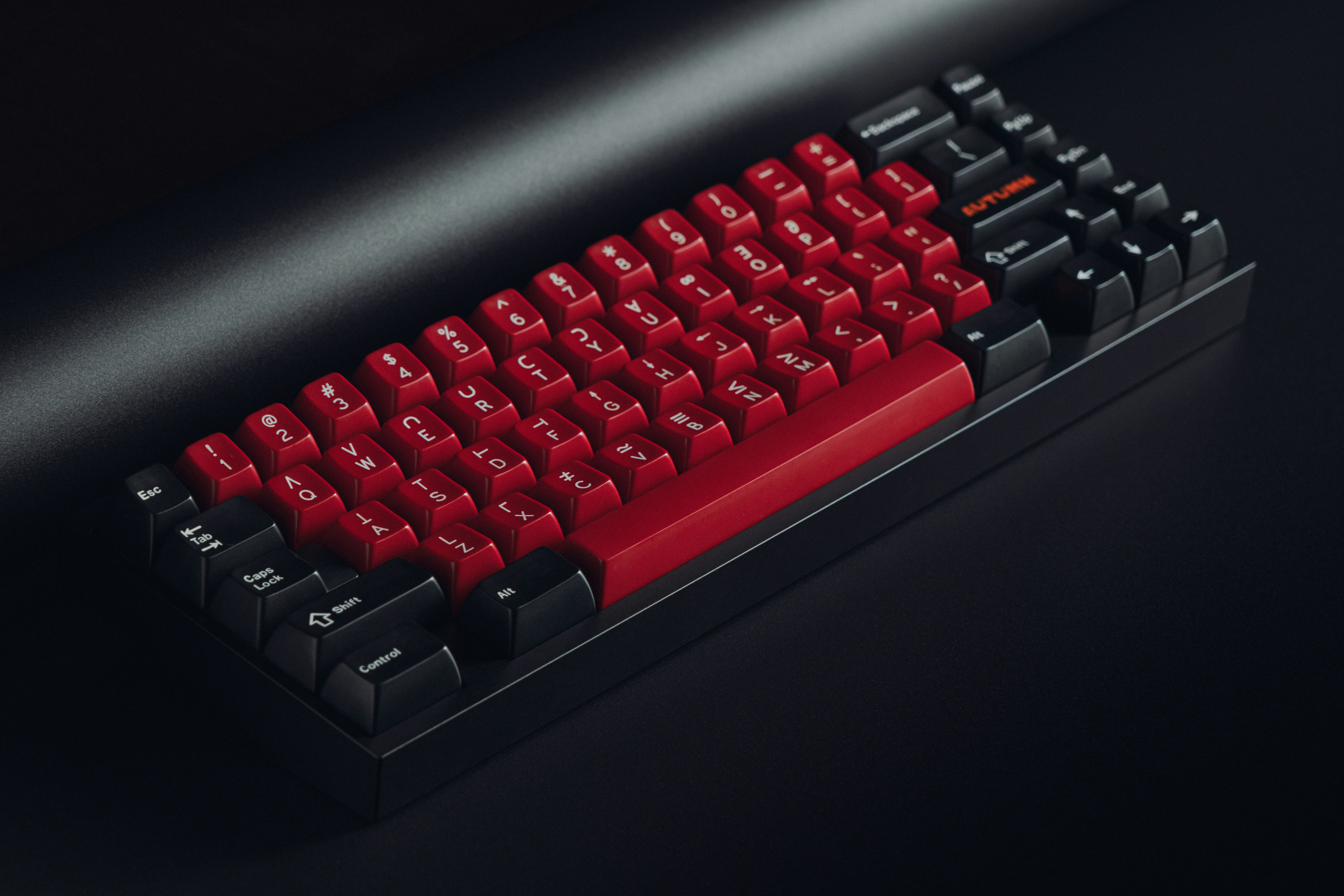A red and black computer keyboard on a black surface photo – Free Setup ...
