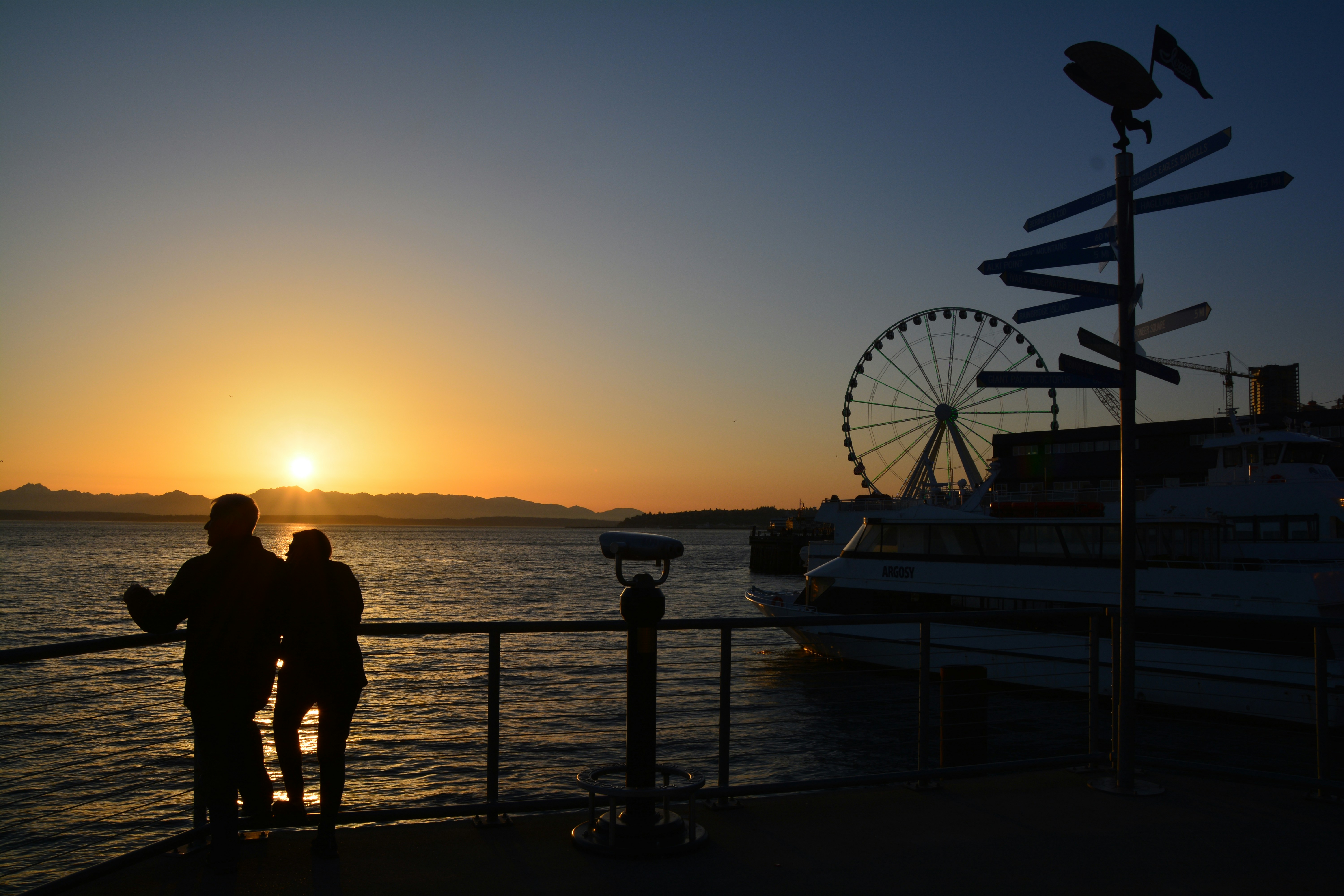 Sunset Silhouettes by the Dock with a Ferris Wheel