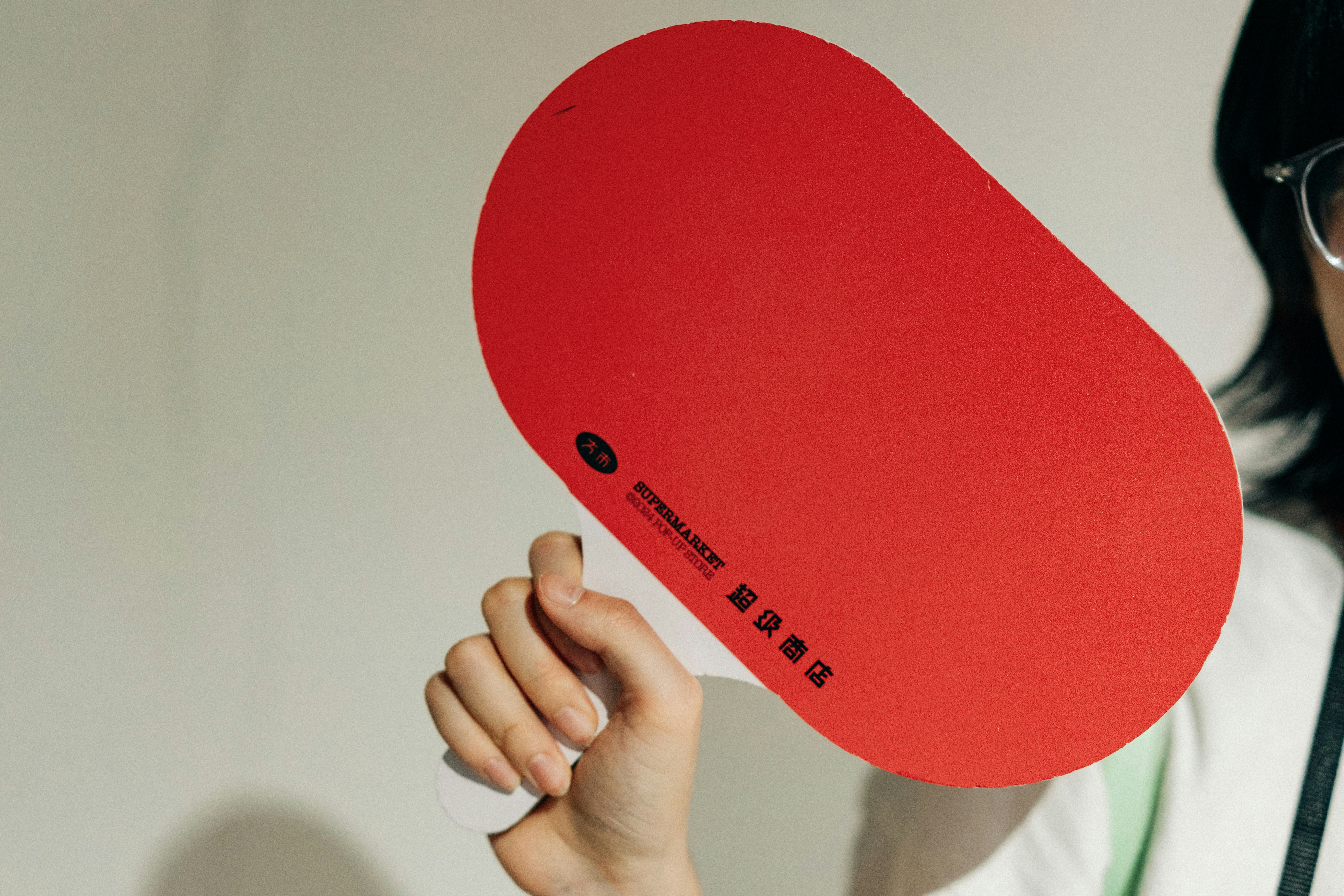 Red Ping Pong of Mystery: A Hand, a Card, a Secret Wink