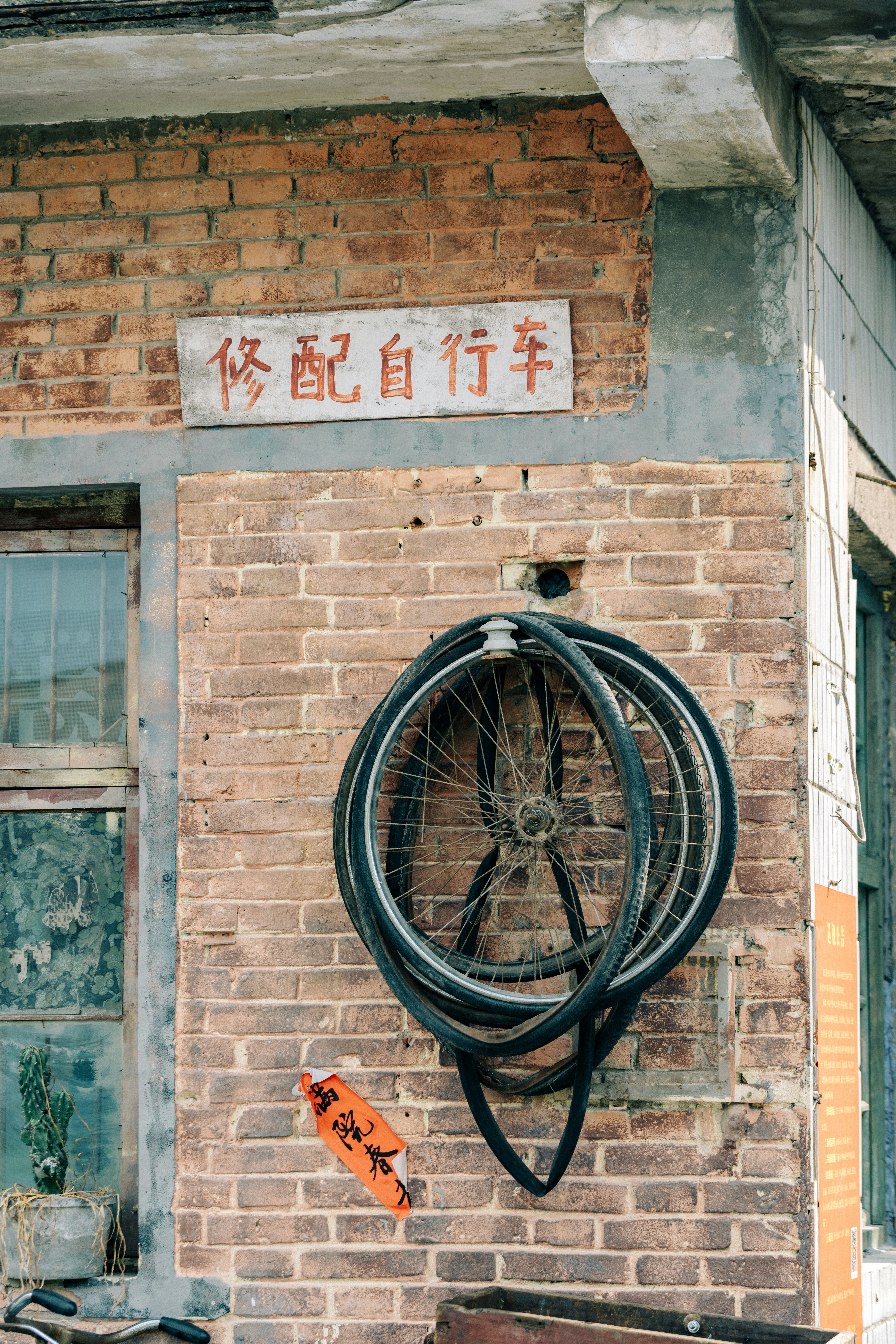 Urban Relic: A Bicycle Wheel Looped into a Brick Facade