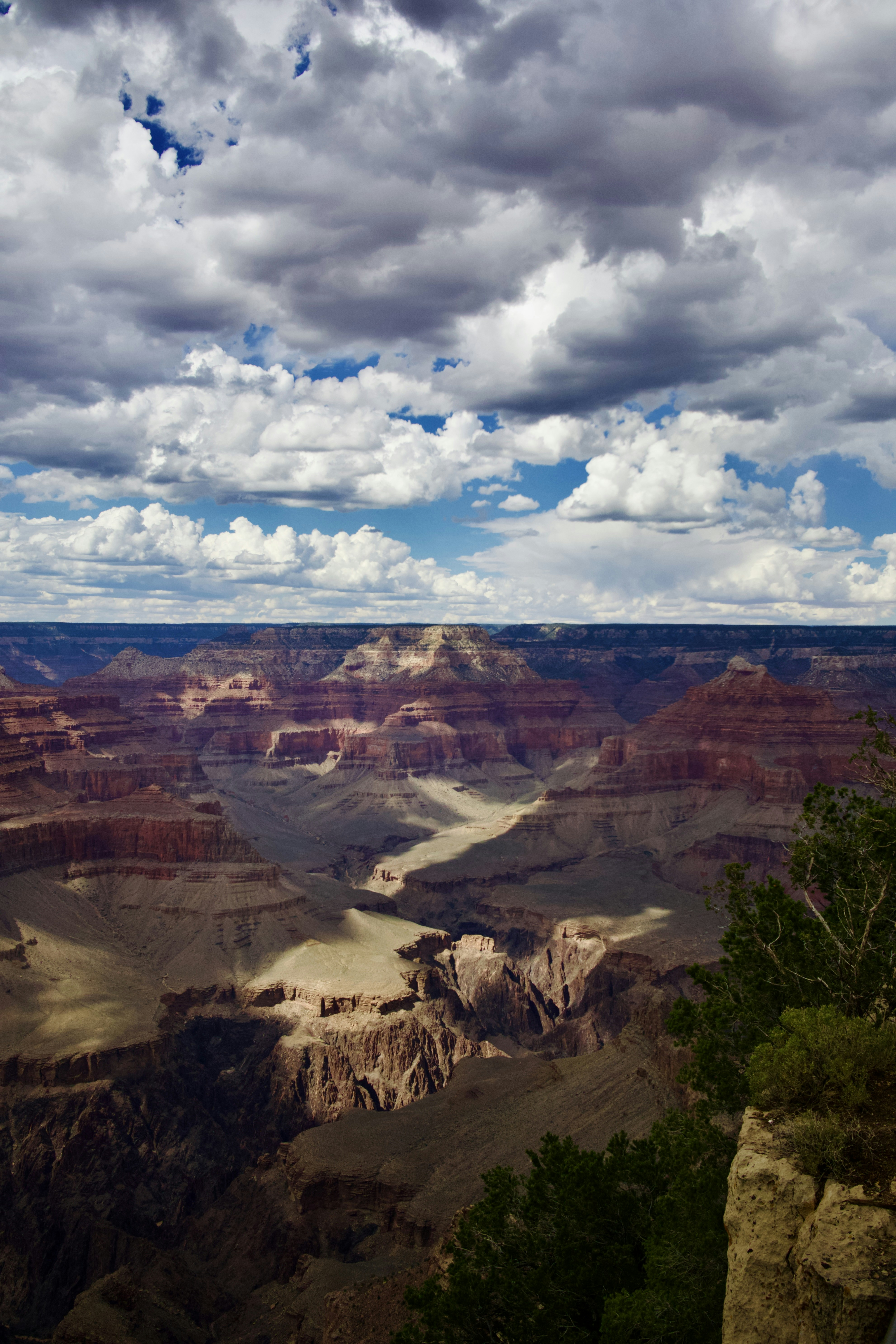 A view of the grand canyon from the rim of a cliff photo – Free Cloud ...