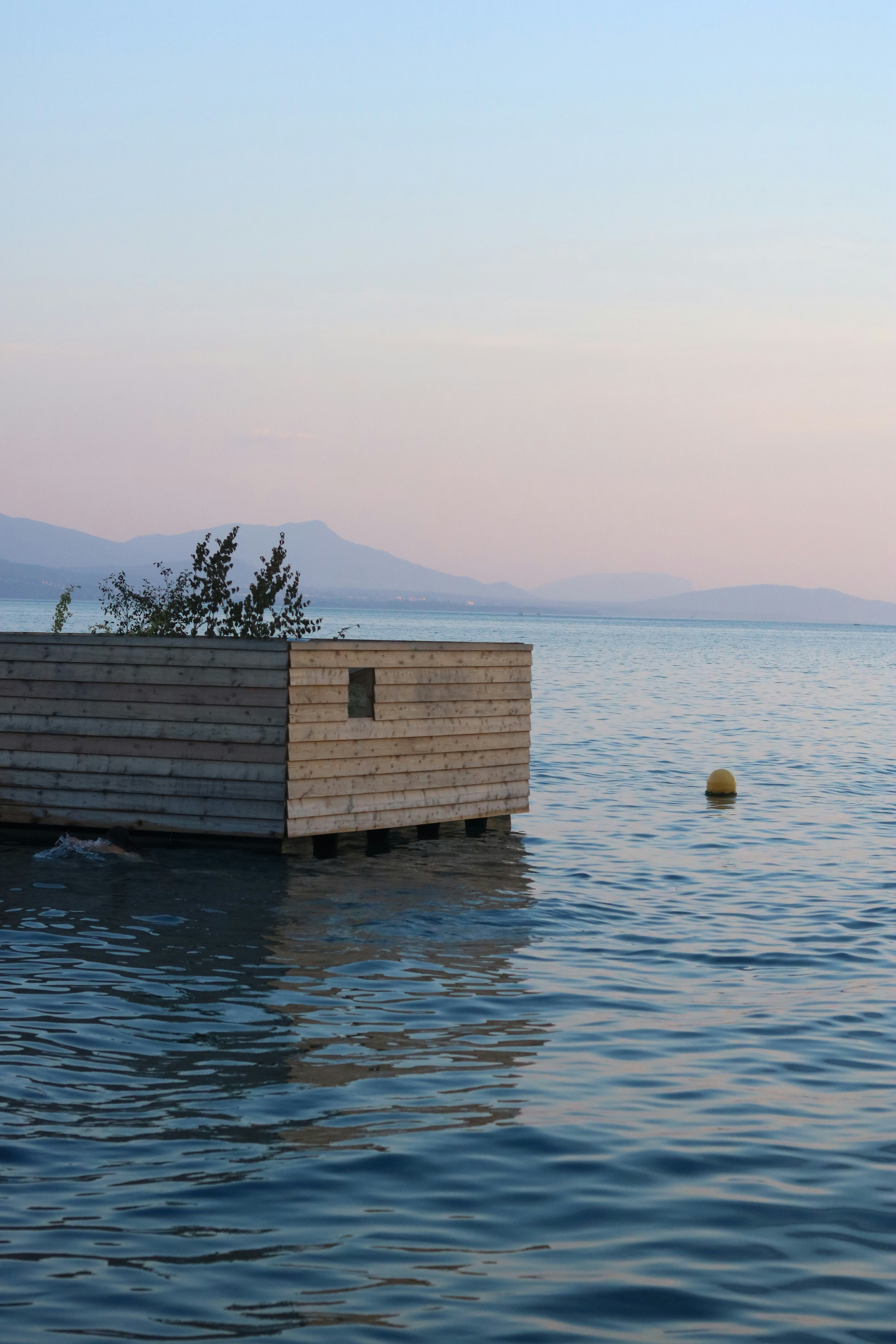 Blue Hour Refuge: Wooden Sea Cabin on Serene Waters