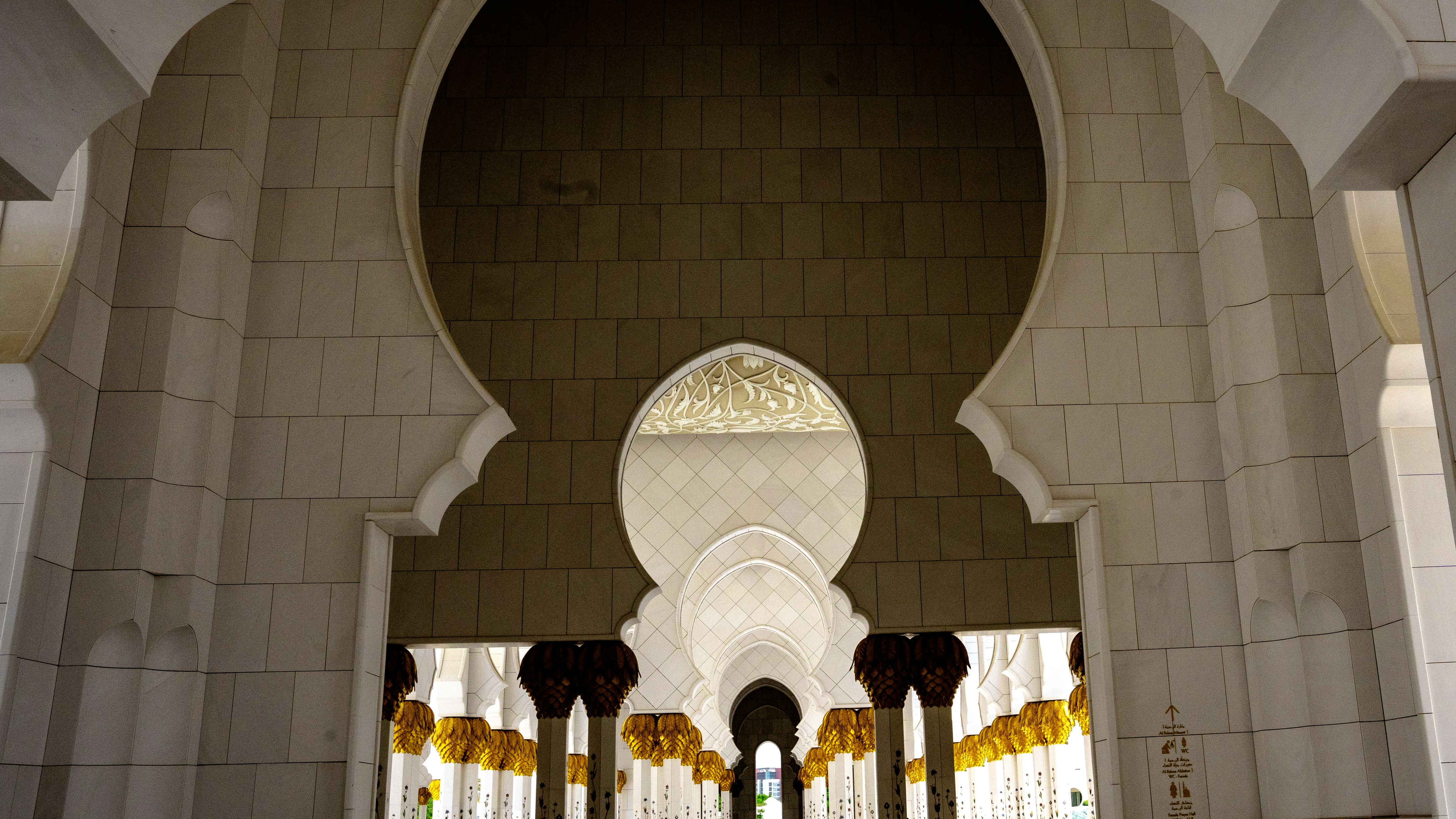 Circular Portal Amidst Golden Drapery: A Symmetric Stone Cathedral