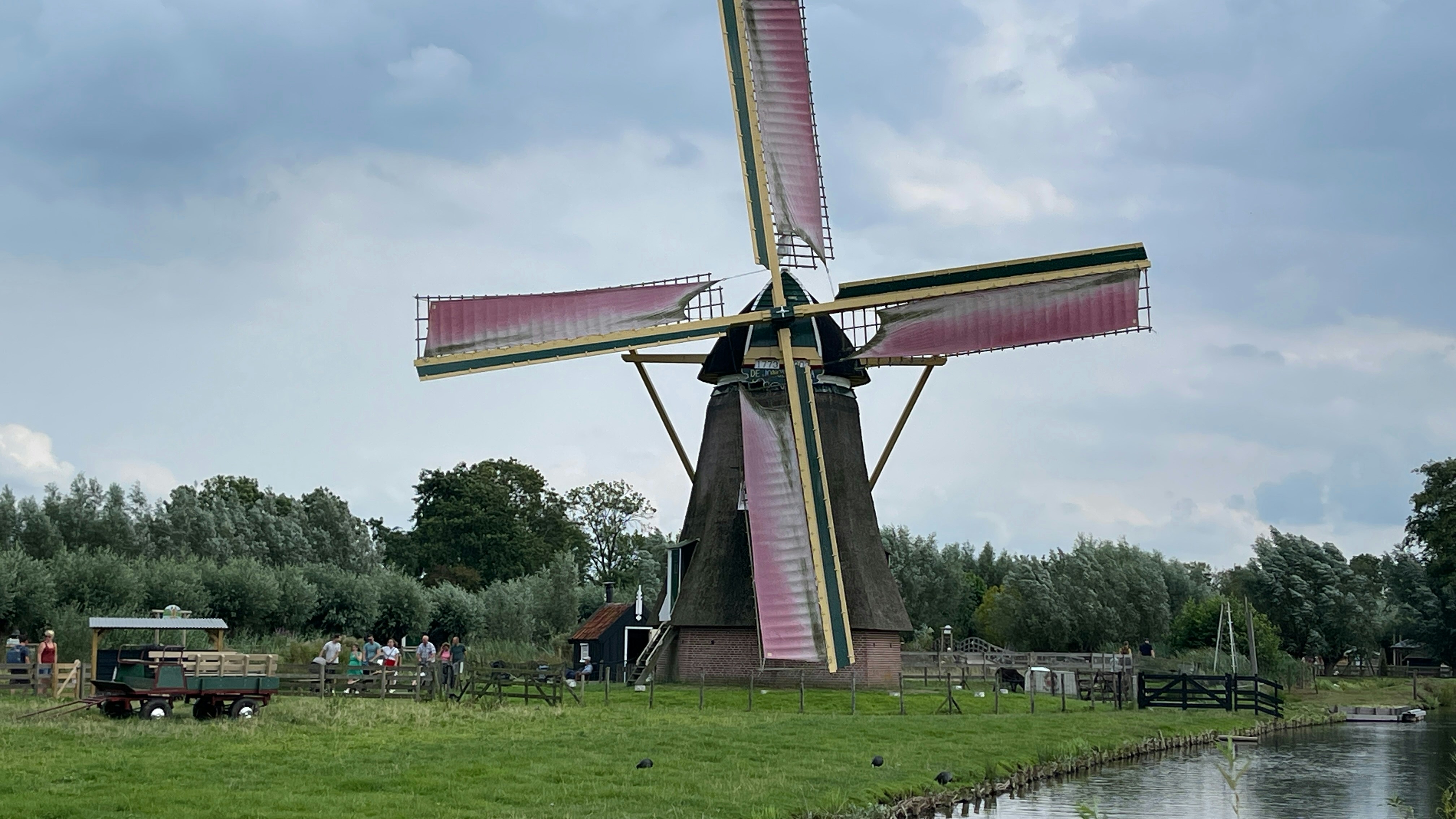 Pastel-Sailed Windmill by the Riverside: A Quiet Dutch-Influenced Countryside Moment