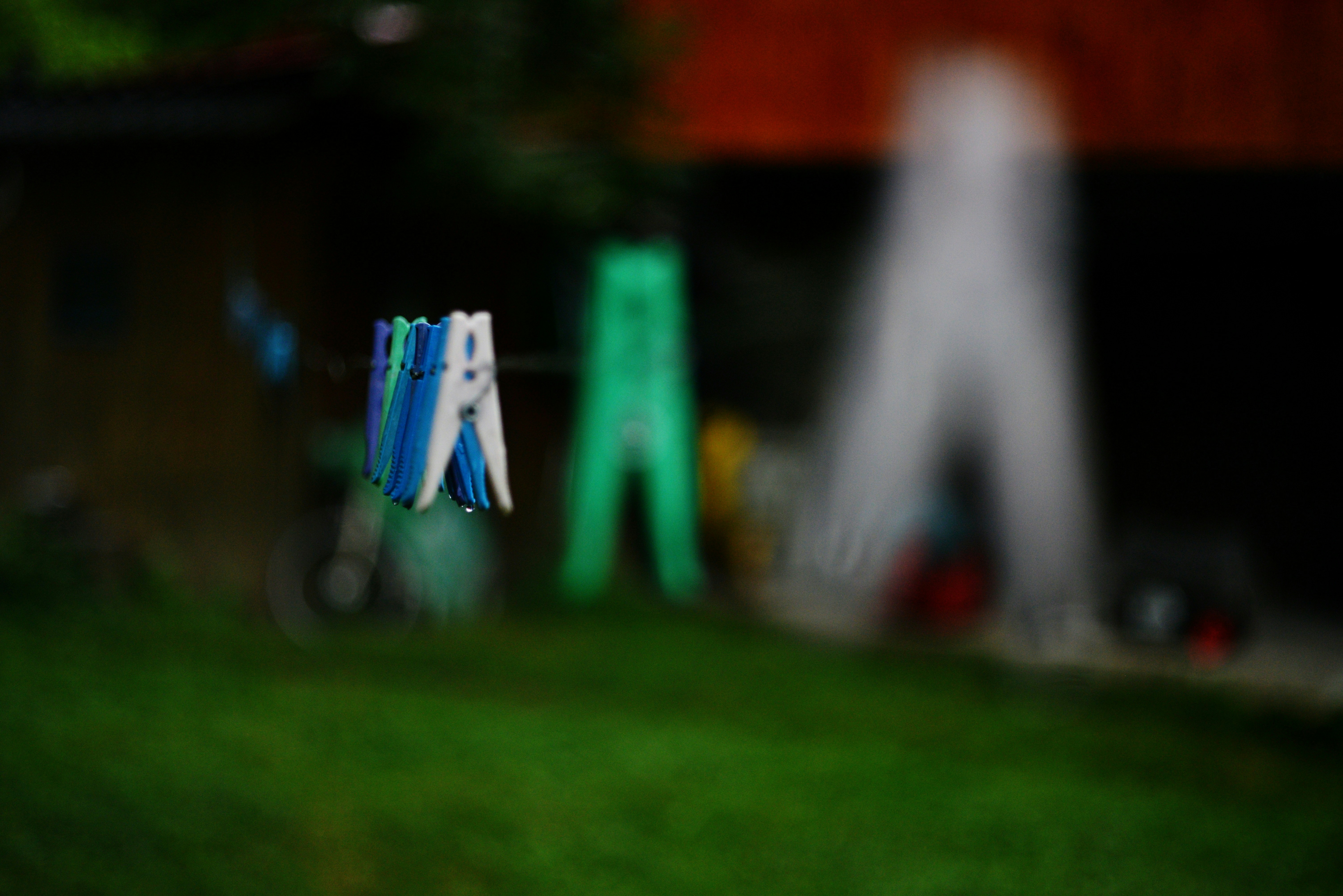 A blurry photo of a lawn with a lawn mower in the foreground