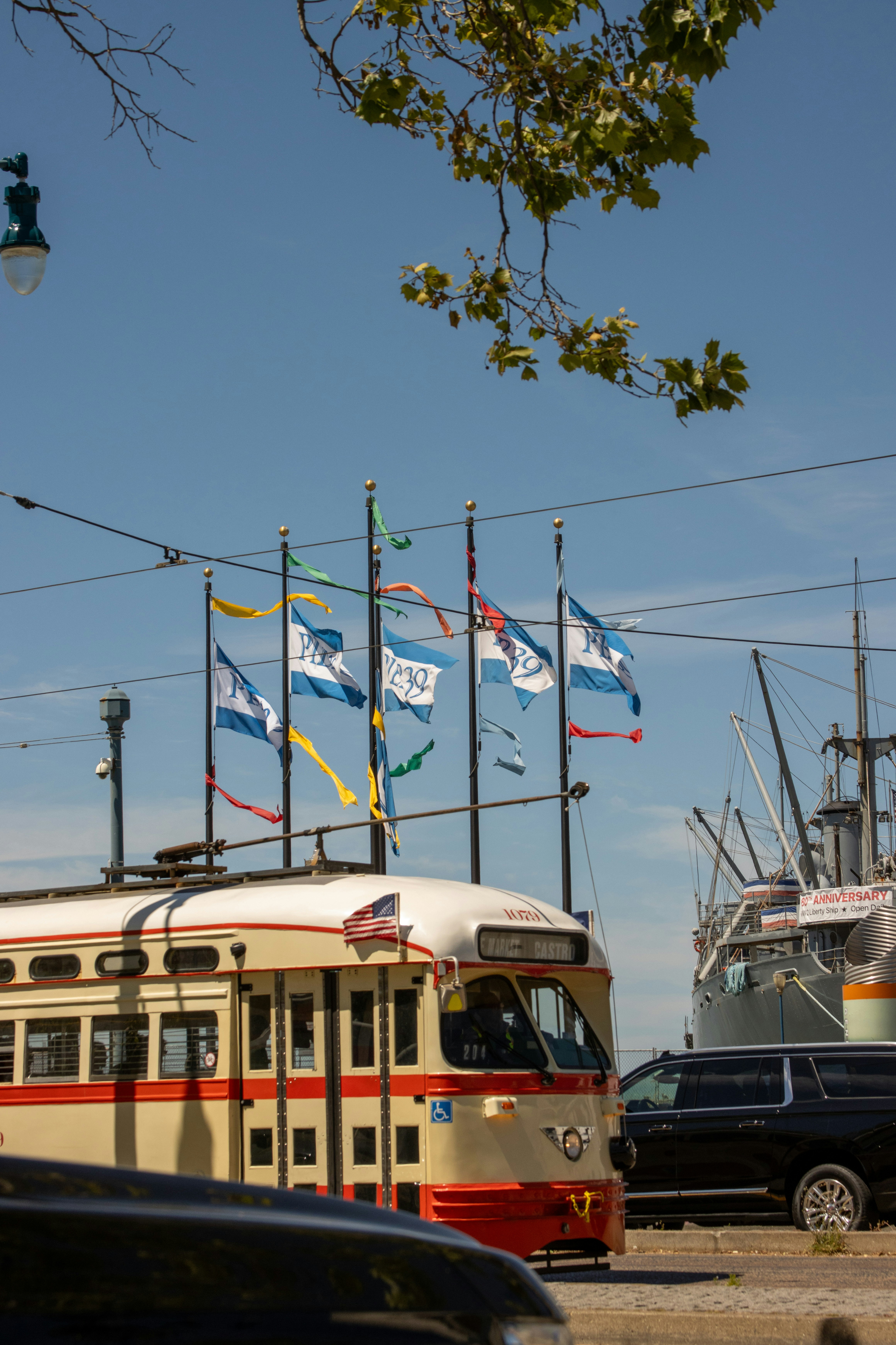 Harborfront Vintage Streetcar Amid Colorful Flags