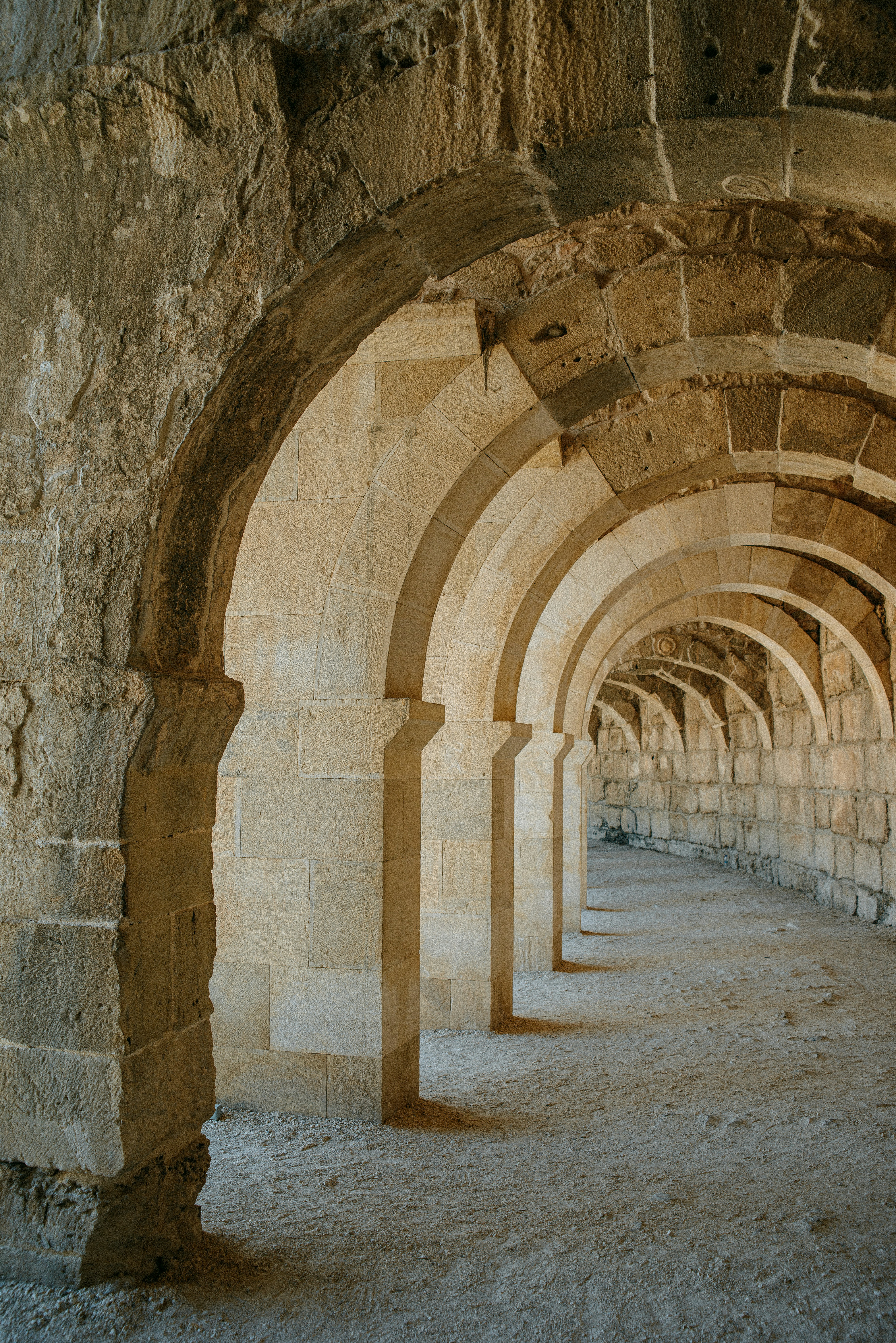 A stone tunnel with a clock on the side of it photo – Free Crypt Image ...
