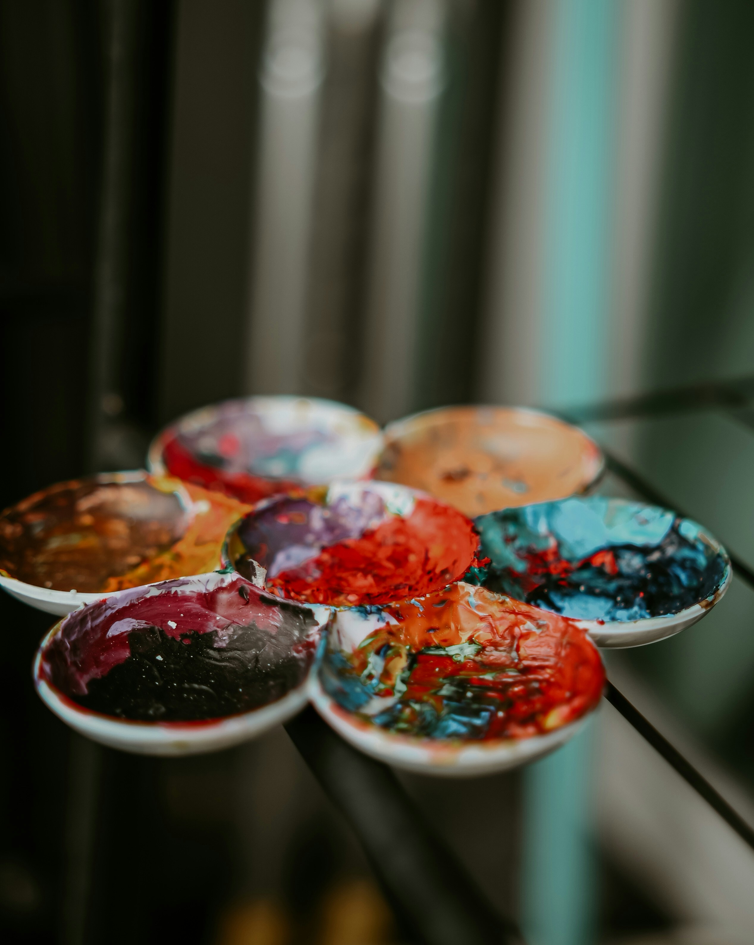 Chromatic Constellation: Ceramic paint bowls on a railing