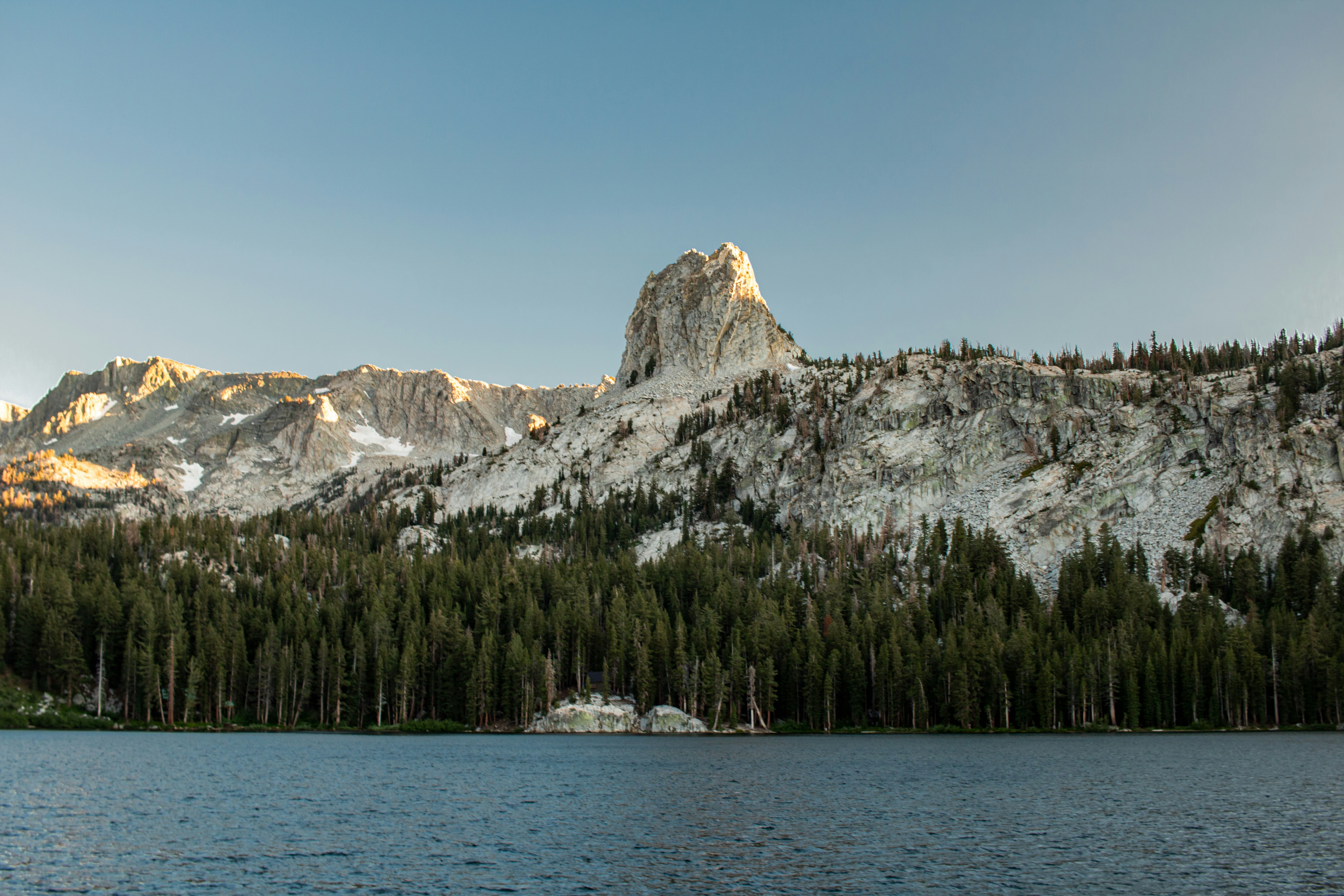 Dawn Summit: Snow-Capped Peak Framed by Lake and Pines