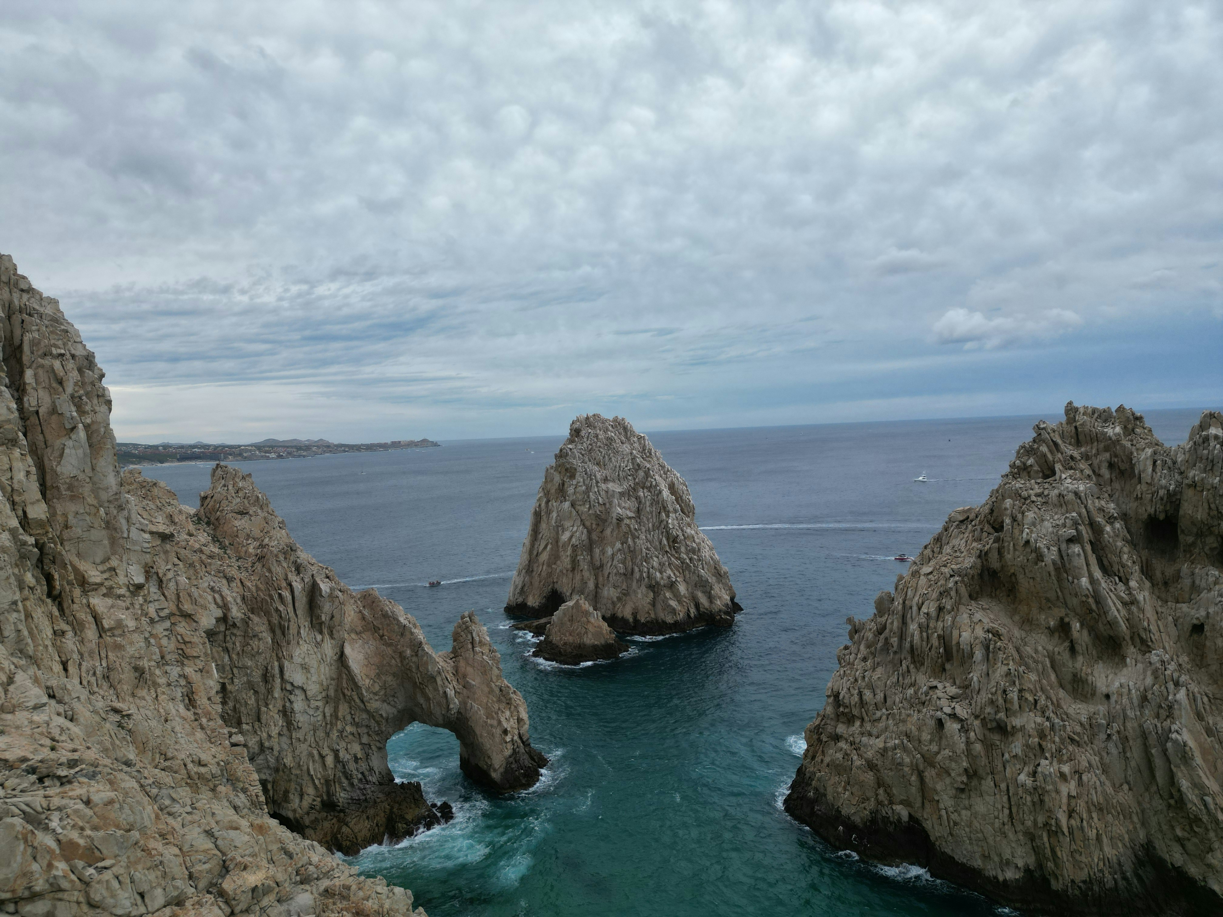 Archway at Sea: Tidal Gate Framed by Weathered Cliffs