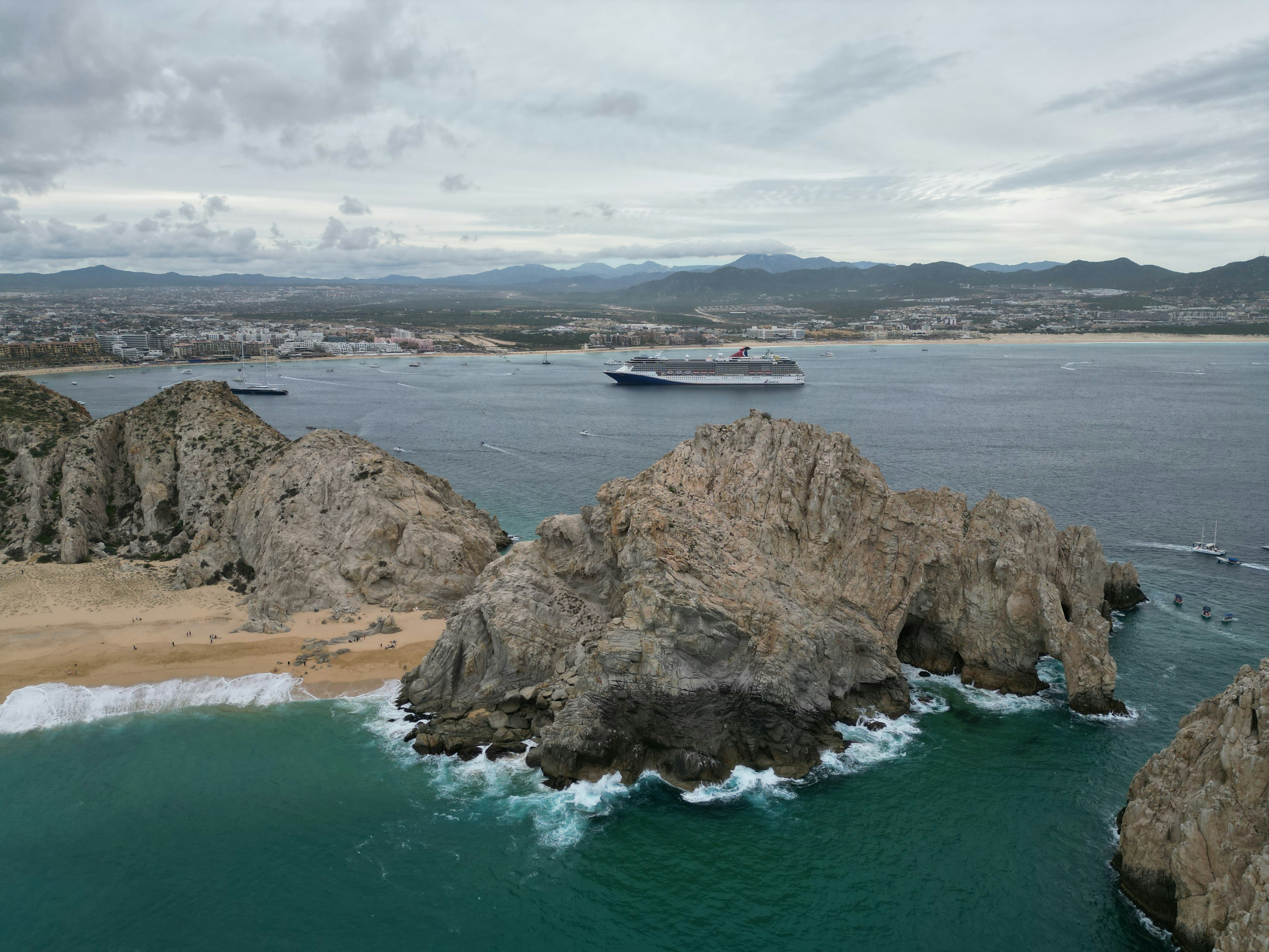 A large body of water surrounded by rocks photo – Free Cabo san lucas ...