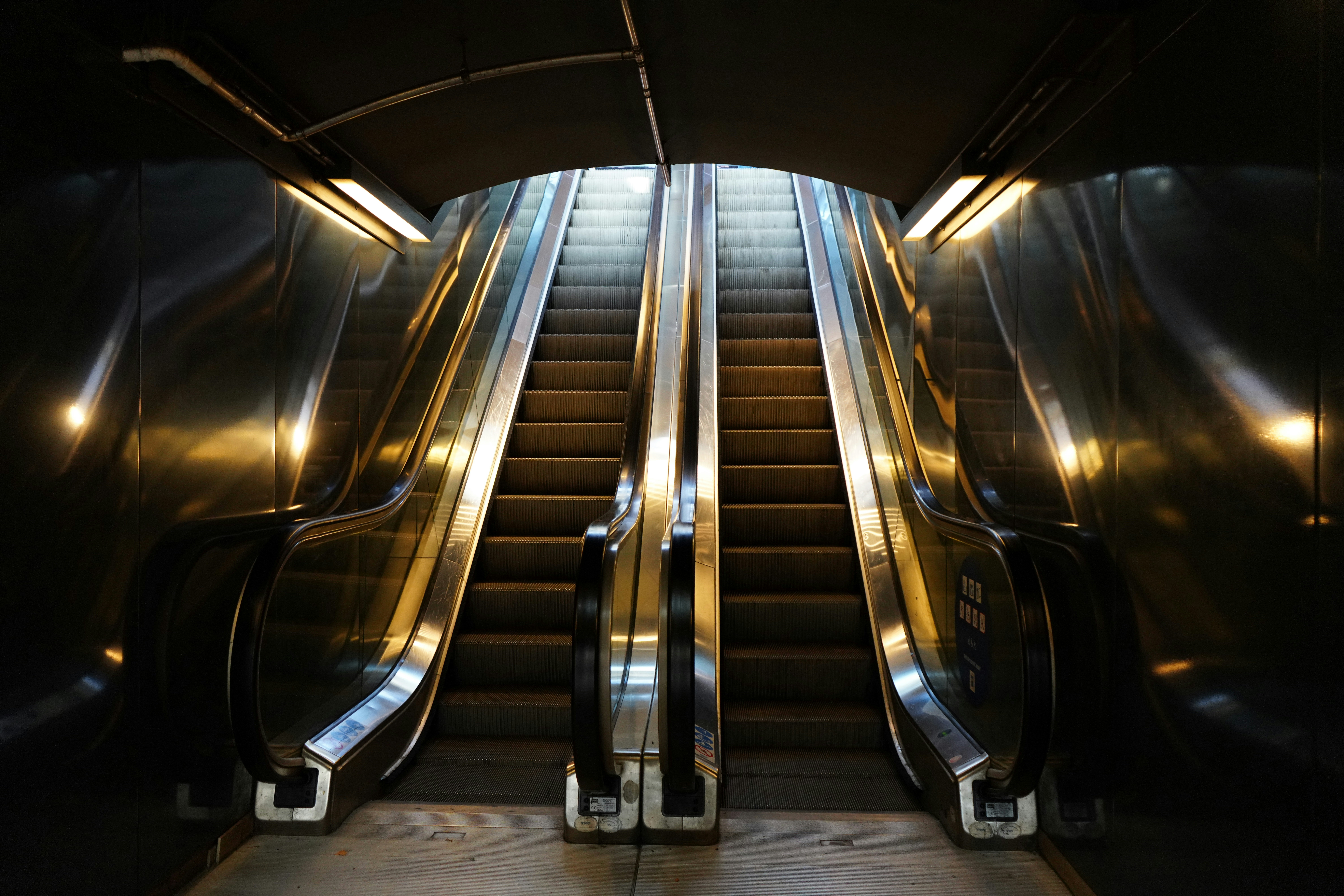 An escalator with two escalators going down it photo – Free House Image ...