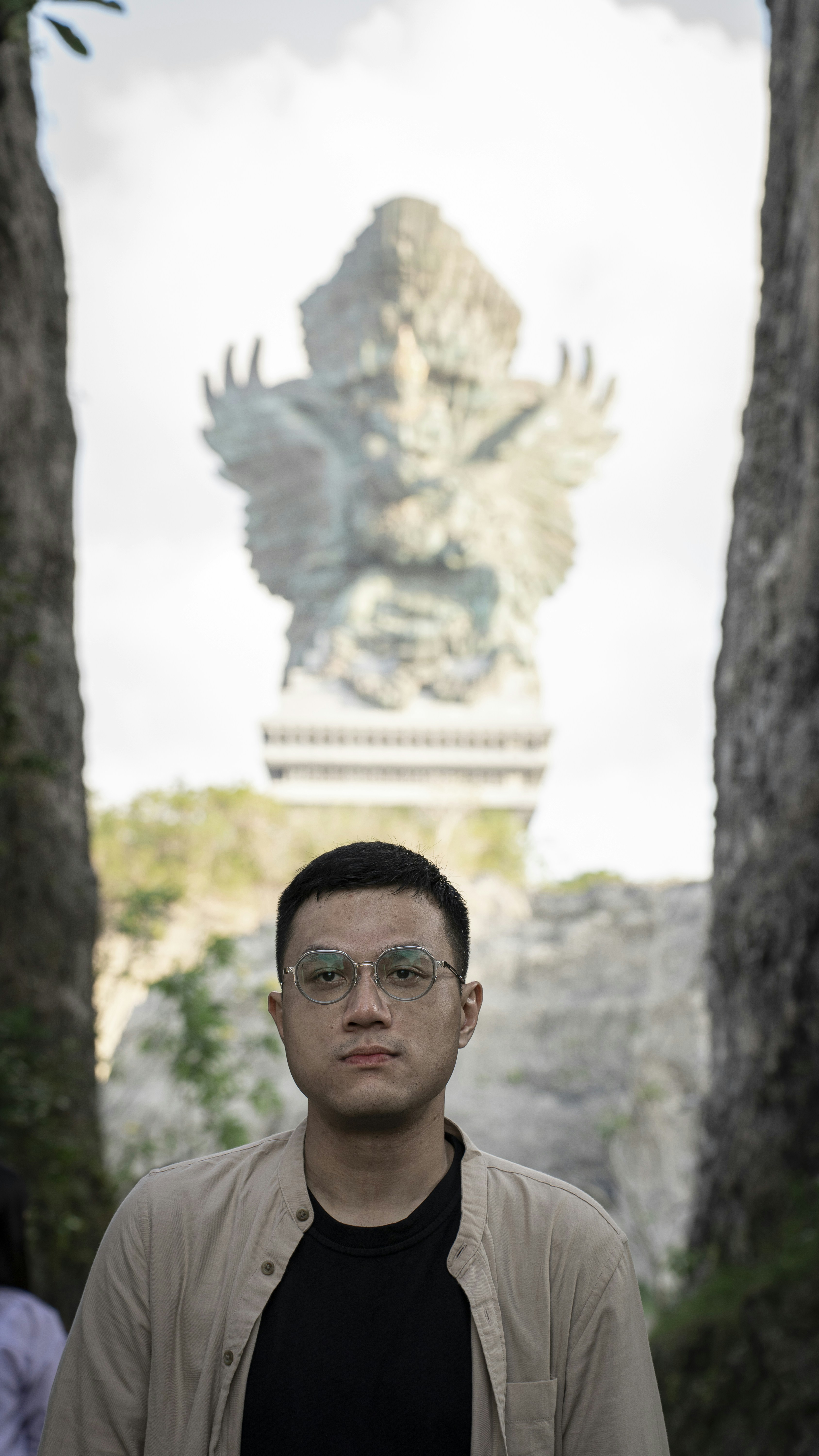 A man standing in front of a large statue photo – Free Garuda wisnu ...