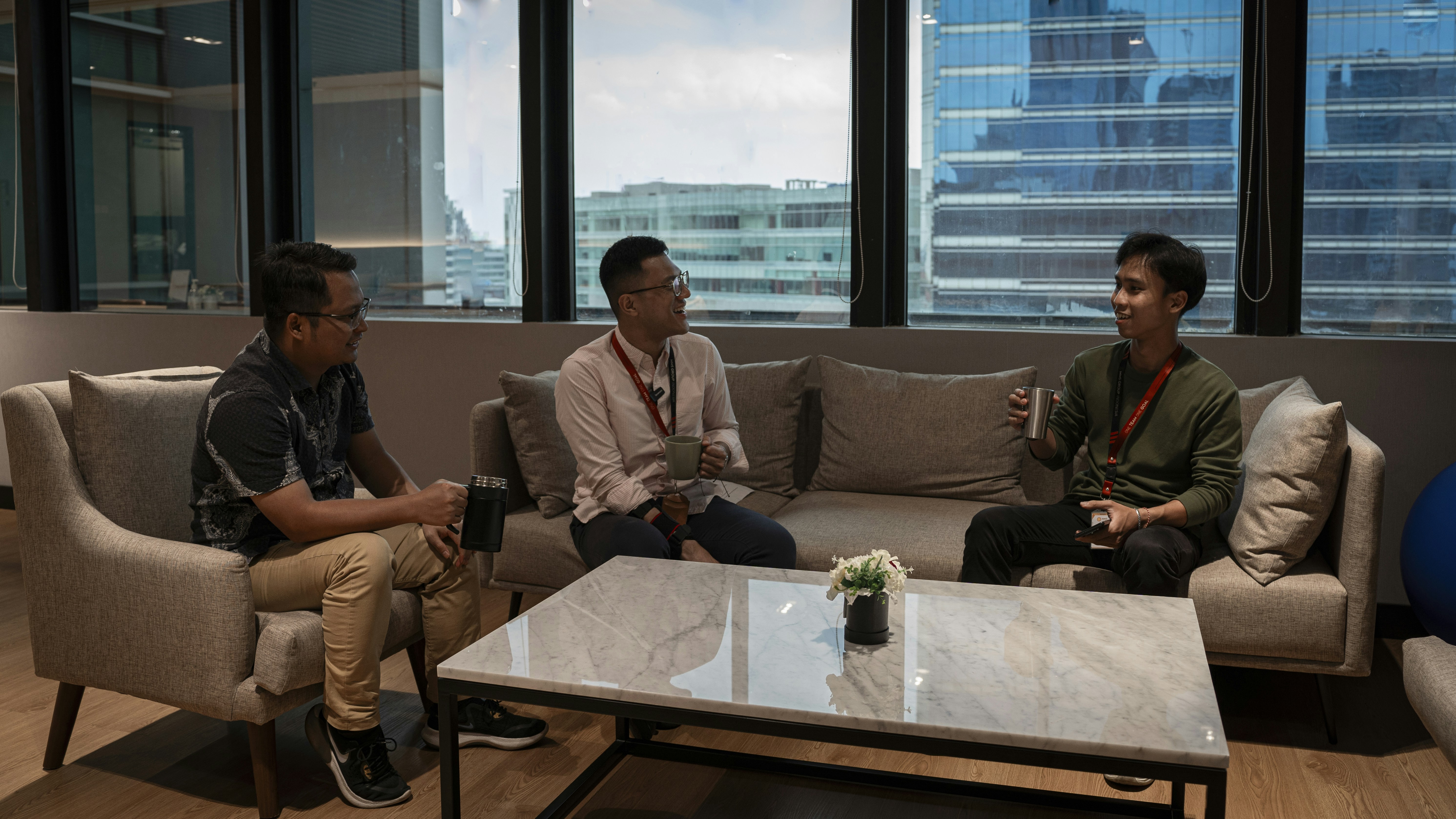 Three men sitting on couches in a living room photo – Free Jakarta ...
