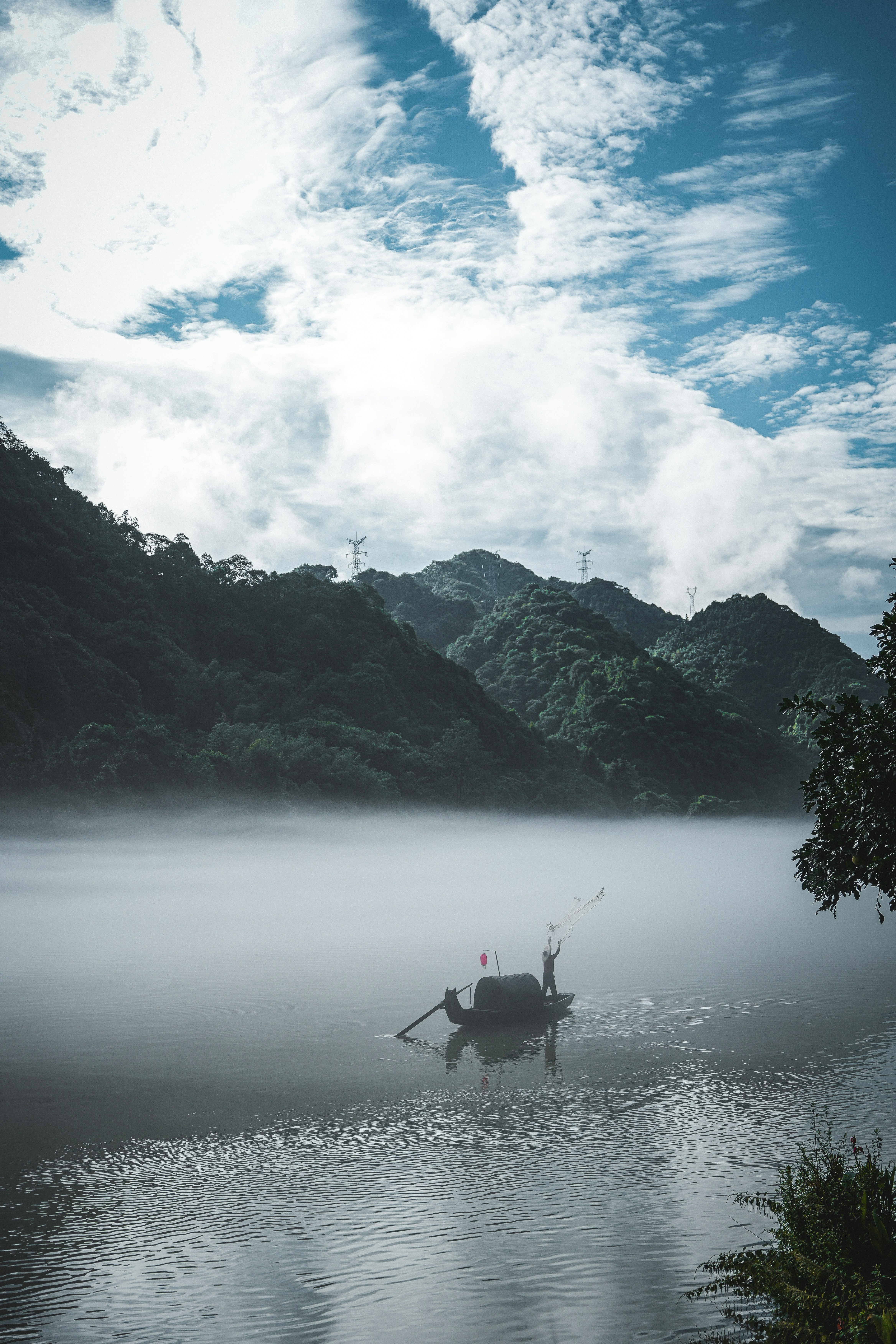 A boat floating on top of a lake surrounded by mountains photo – Free ...