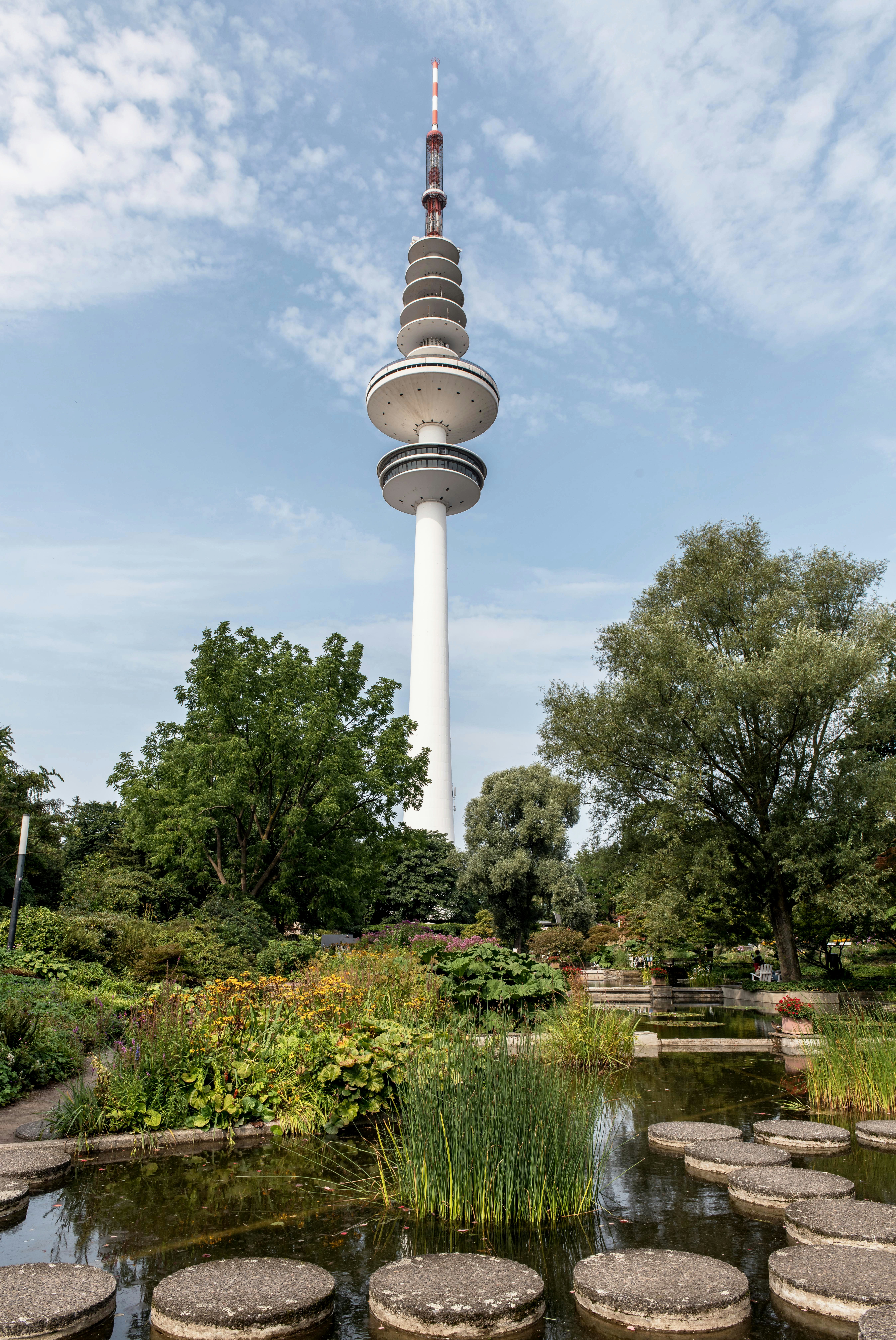 Vertical Sentinel: Berlin's Fernsehturm rising over a serene city garden