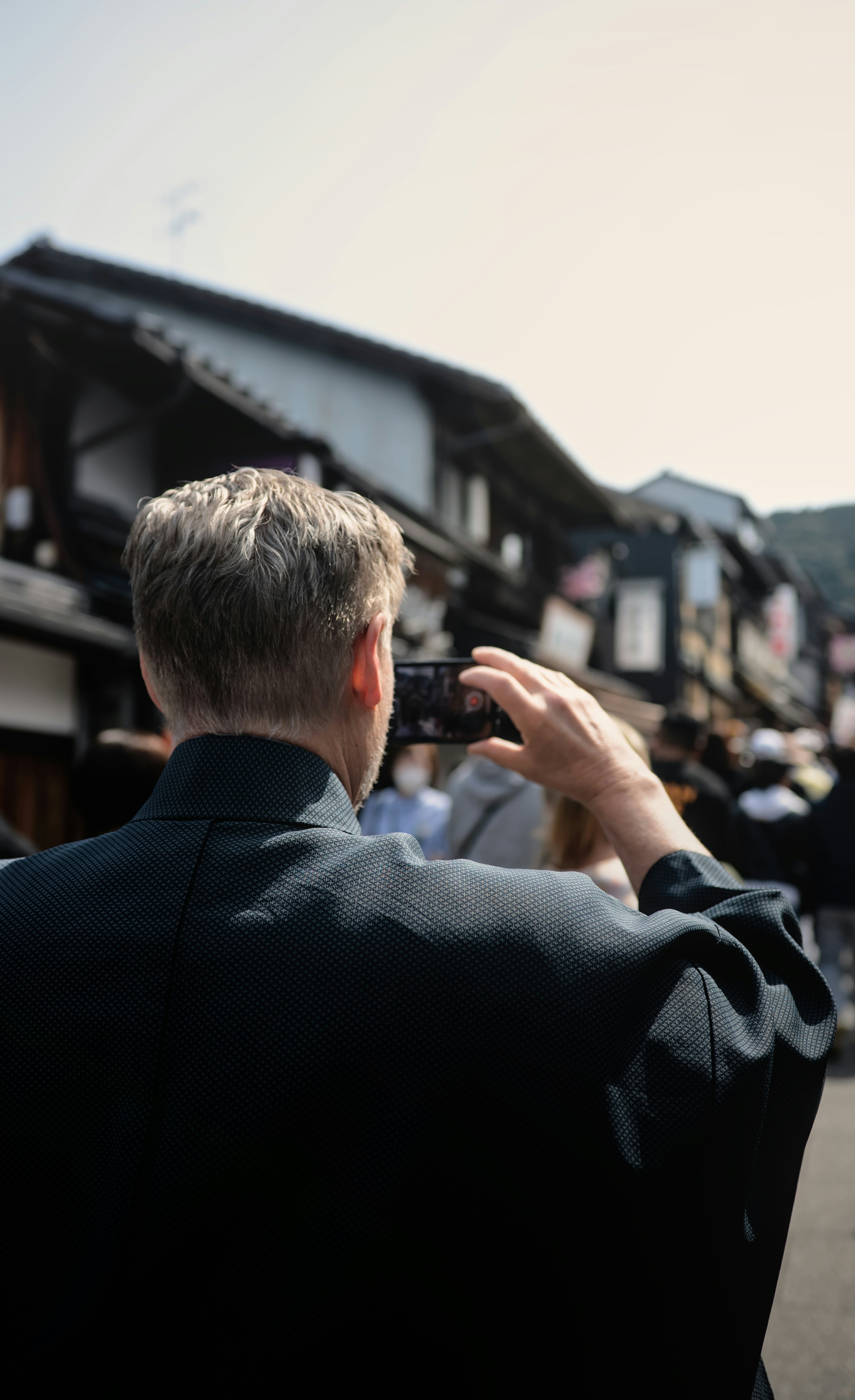Backlit Street Moment: A Photographer Framing the Scene