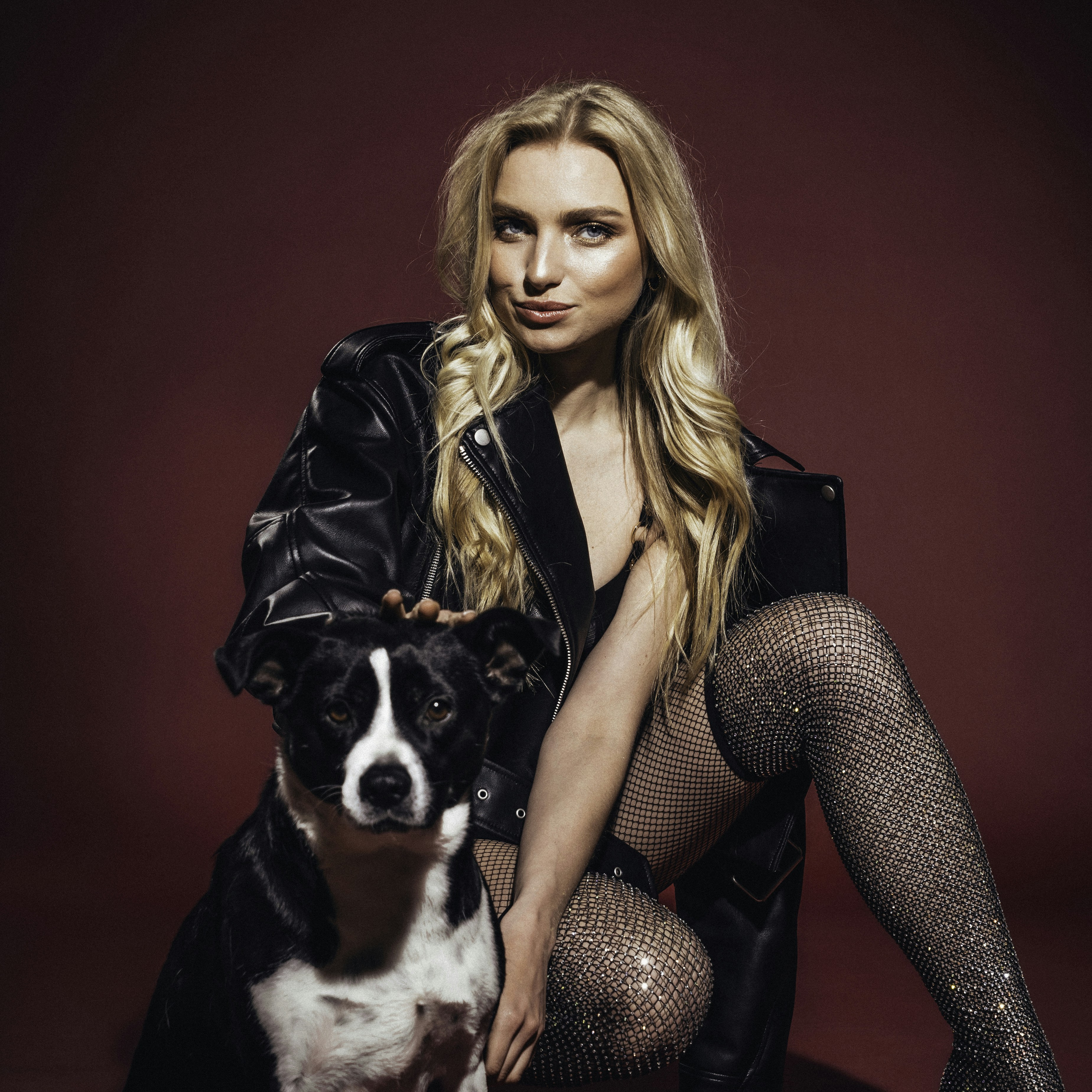 Crimson Studio Gaze: Glamour in Leather and a Loyal Canine