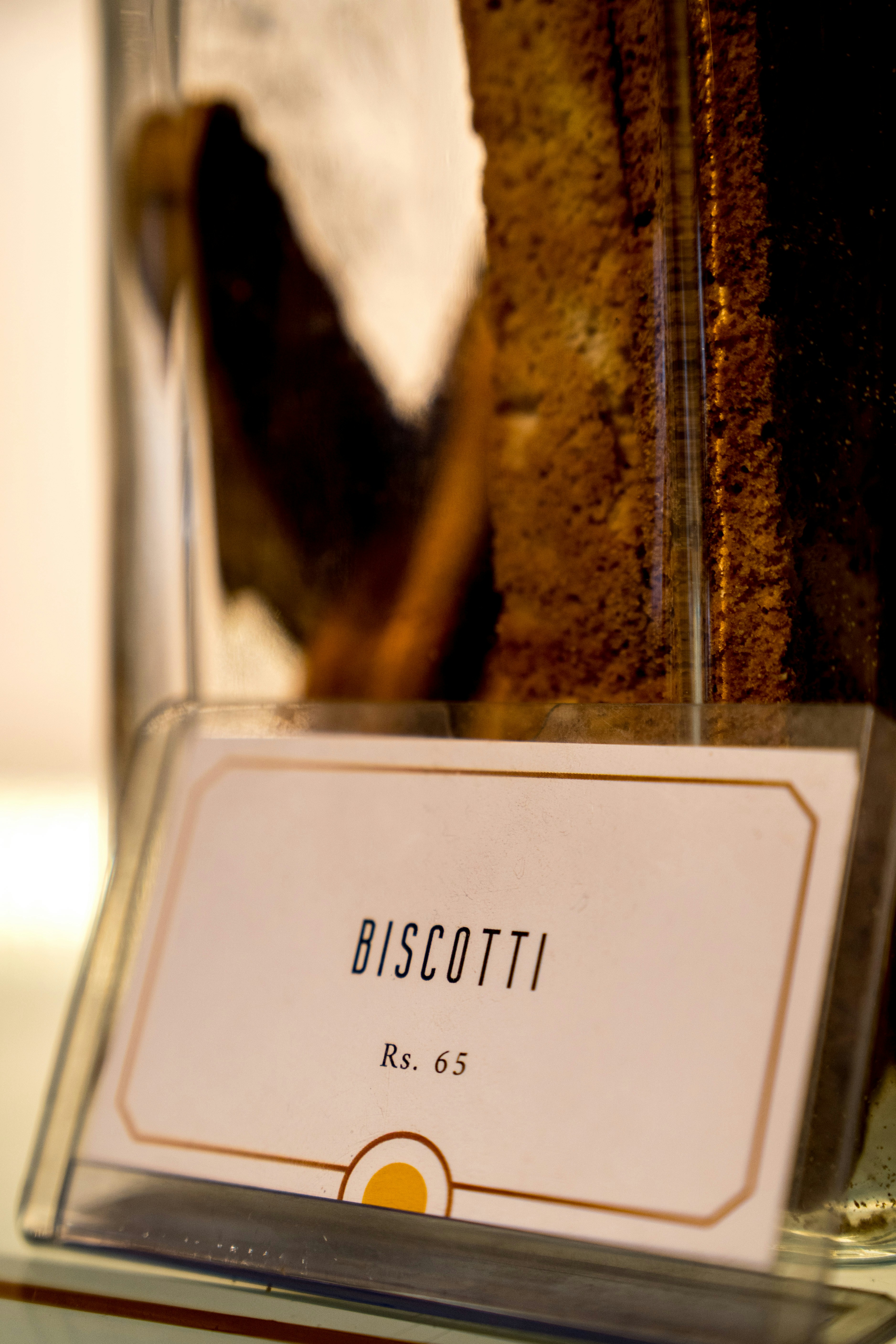 Biscotti Label in a Softly Lit Glass Display