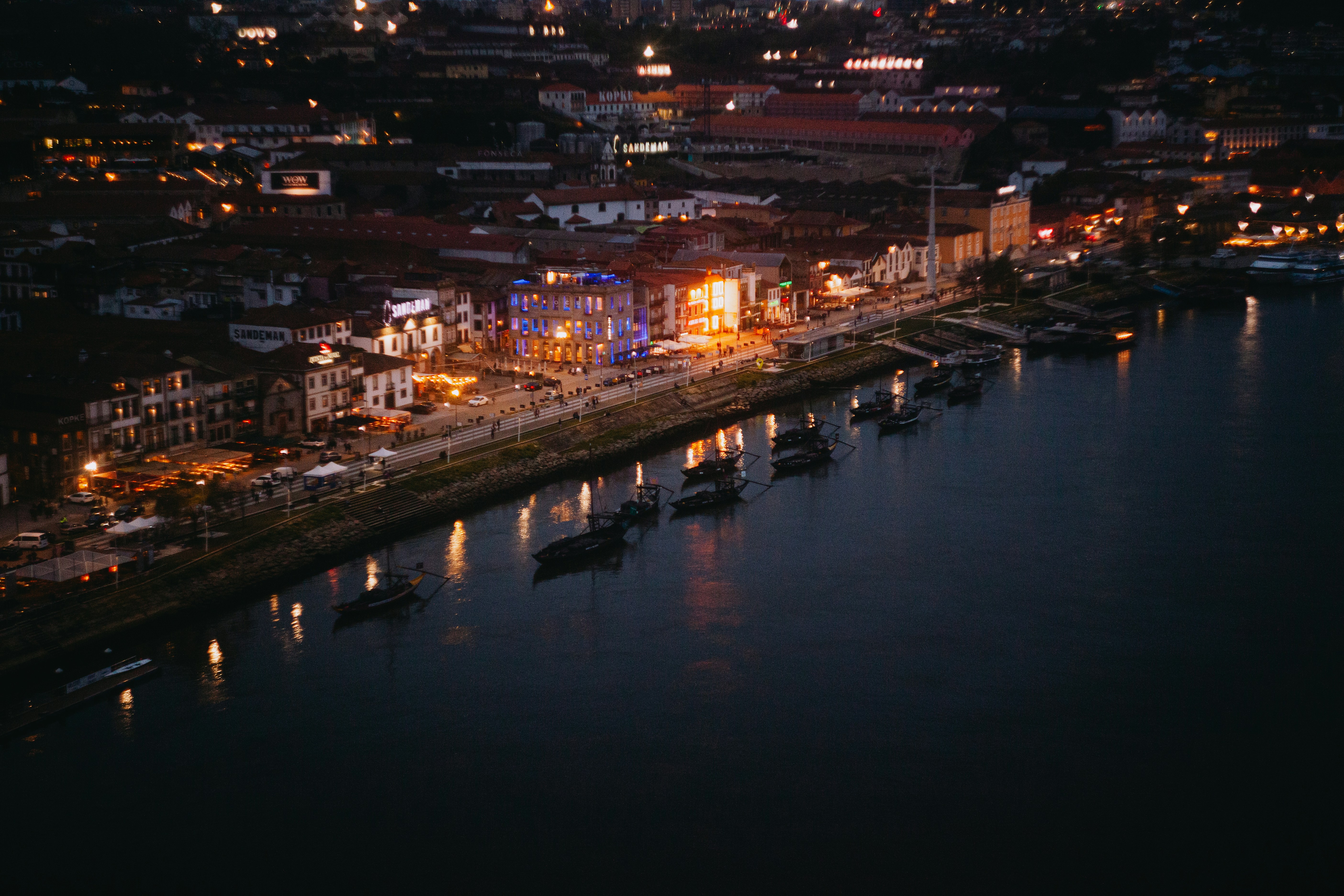 Harbor Lights Over Quiet Water: An Aerial Nightscape of a Riverside Town