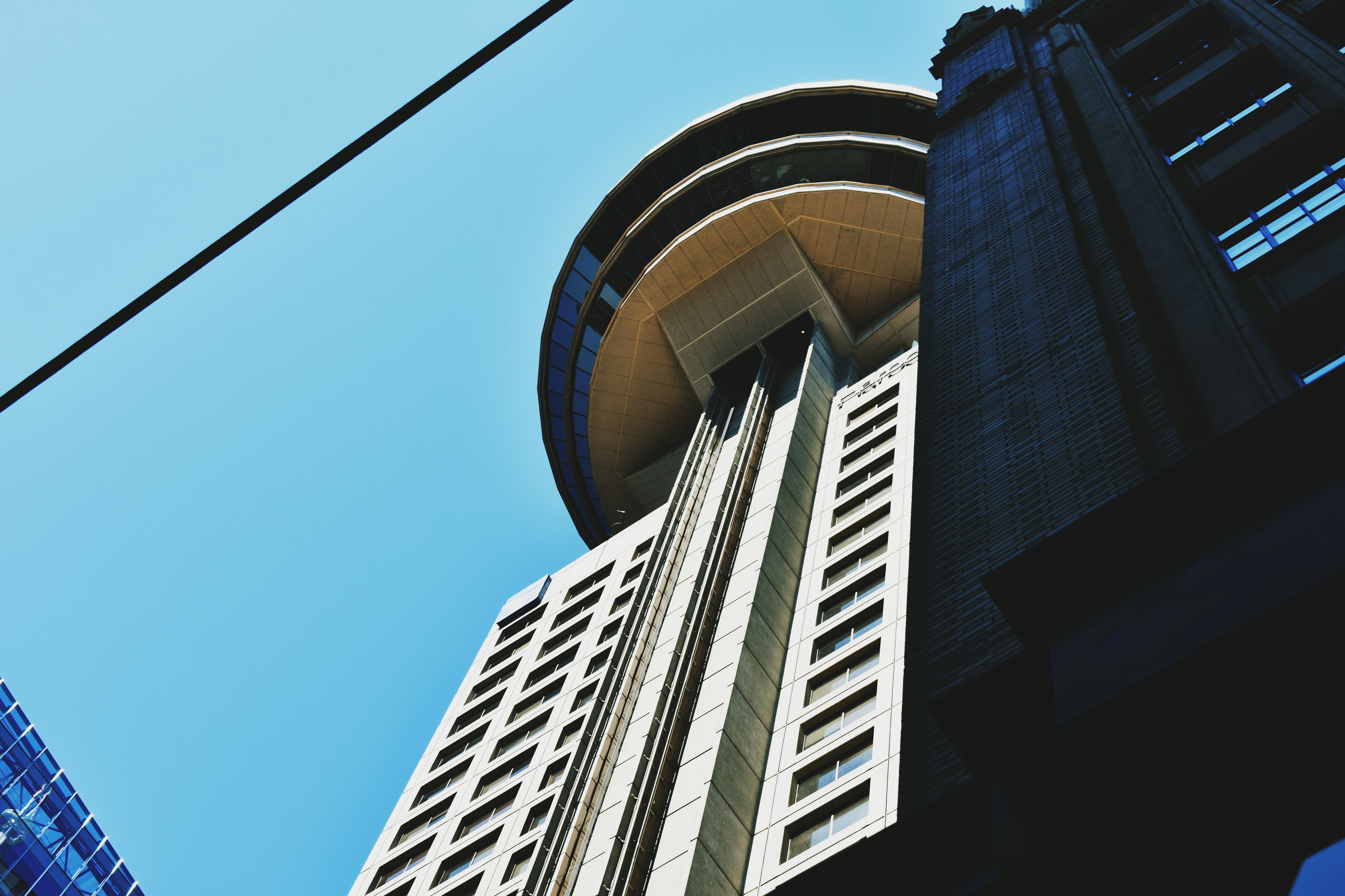 Circling Crown: A Low-Angle Portrait of a Tower with a Circular Observation Deck