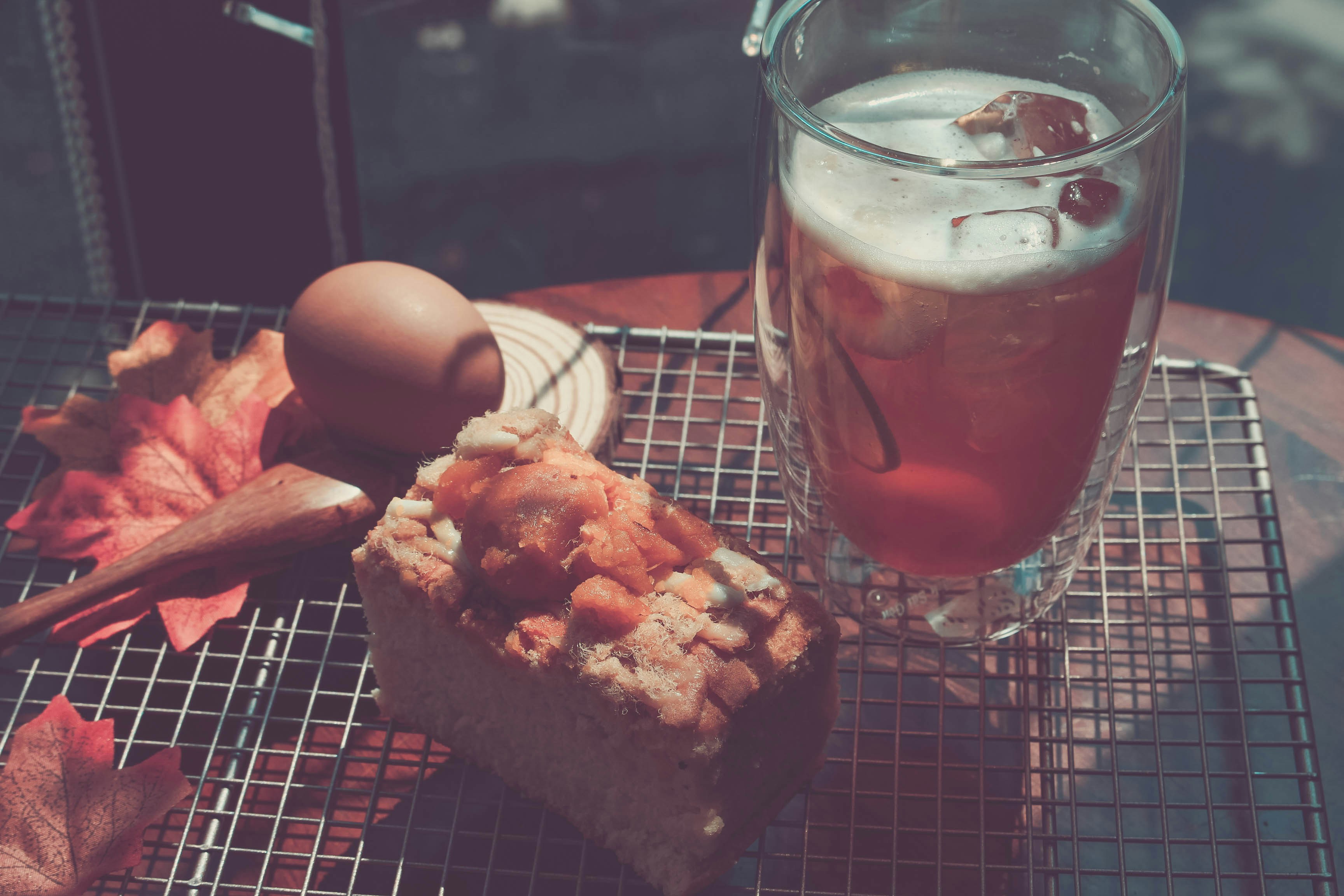 Crumb-Topped Morning: Muffin Slice on a Wire Rack Beside an Iced Glass
