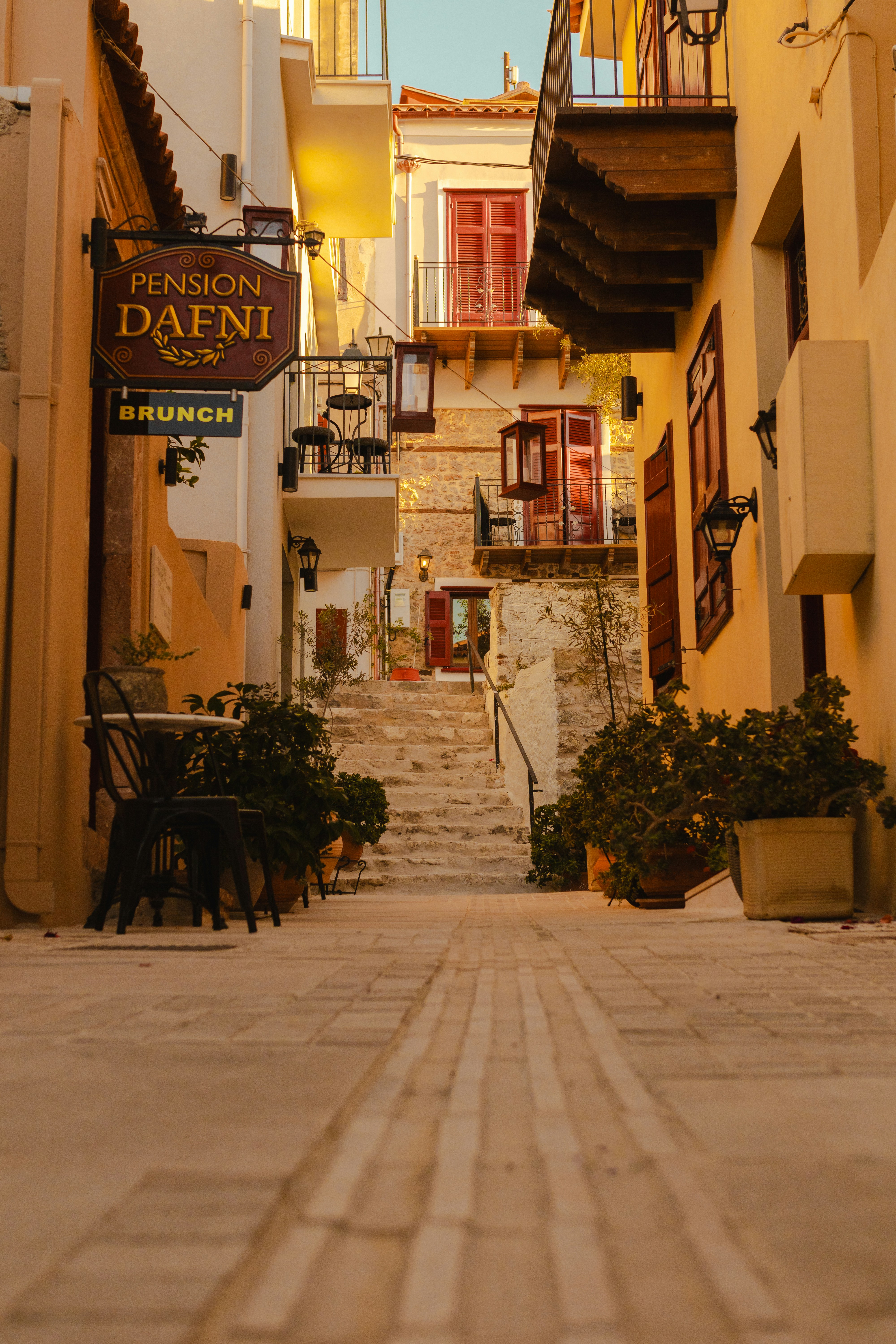 Golden Staircase in a Sunlit Mediterranean Alley