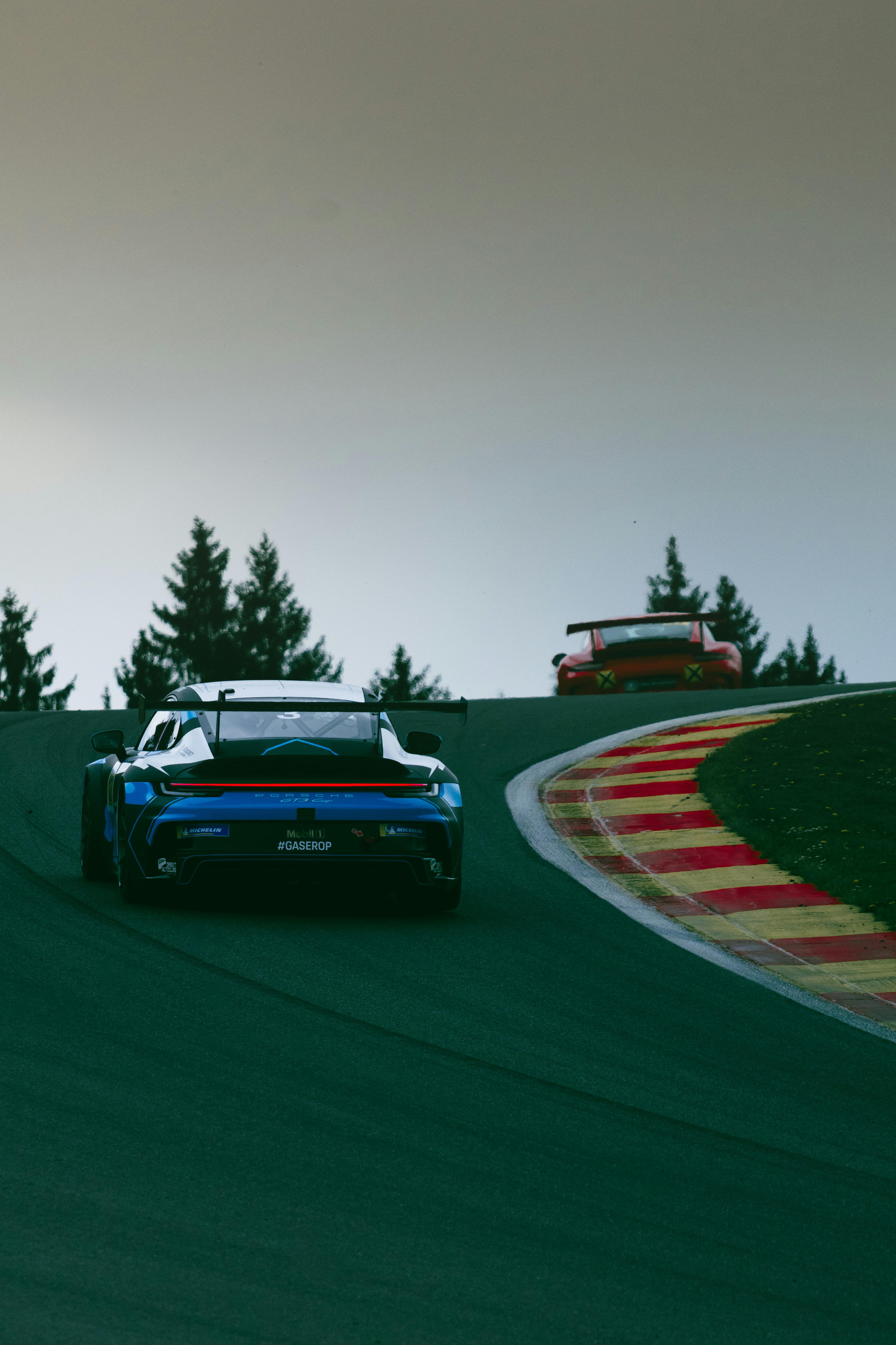 Blue Apex: Leading the Crest on a Winding Race Track
