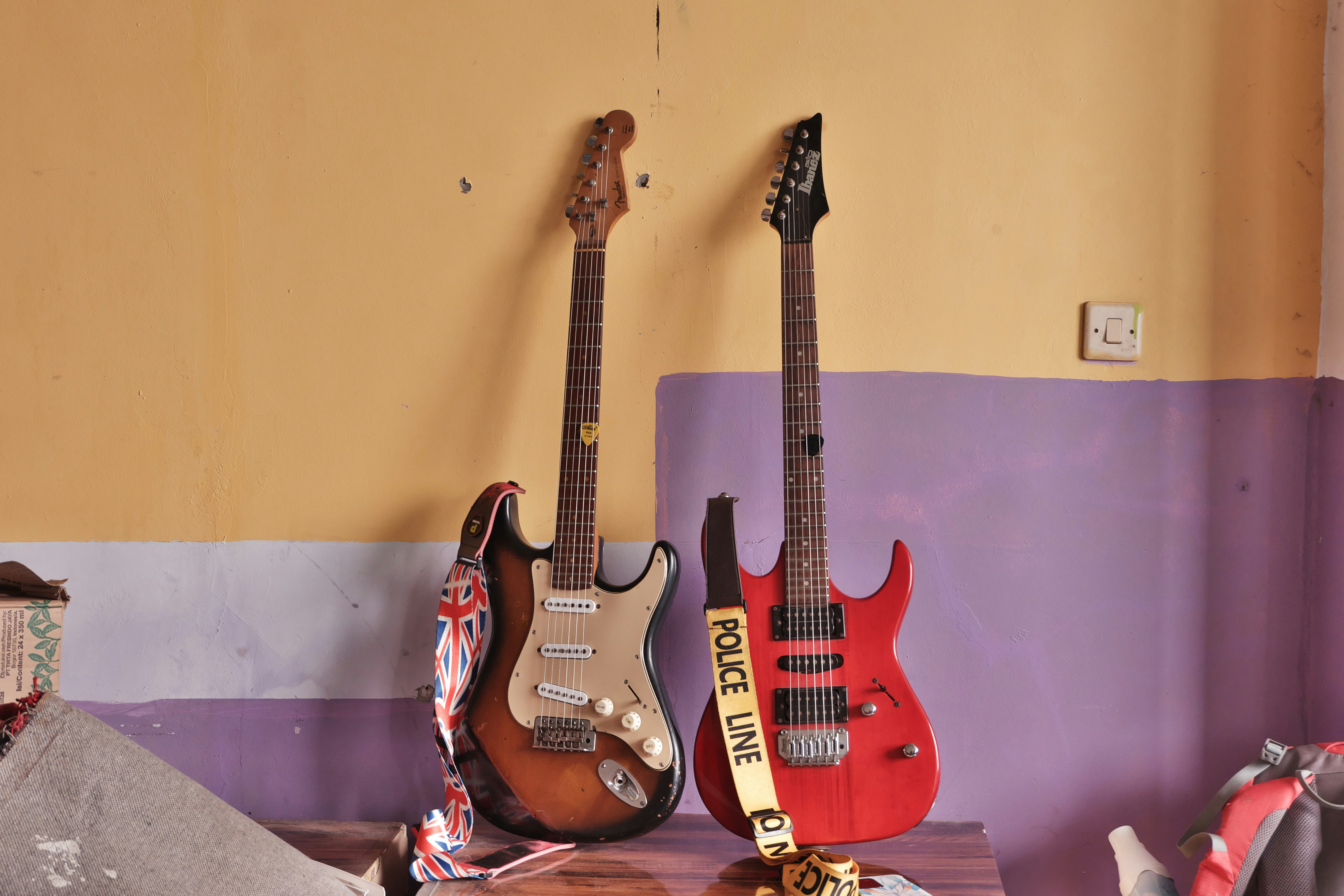 A group of guitars hanging on a wall photo – Free Musical instrument ...